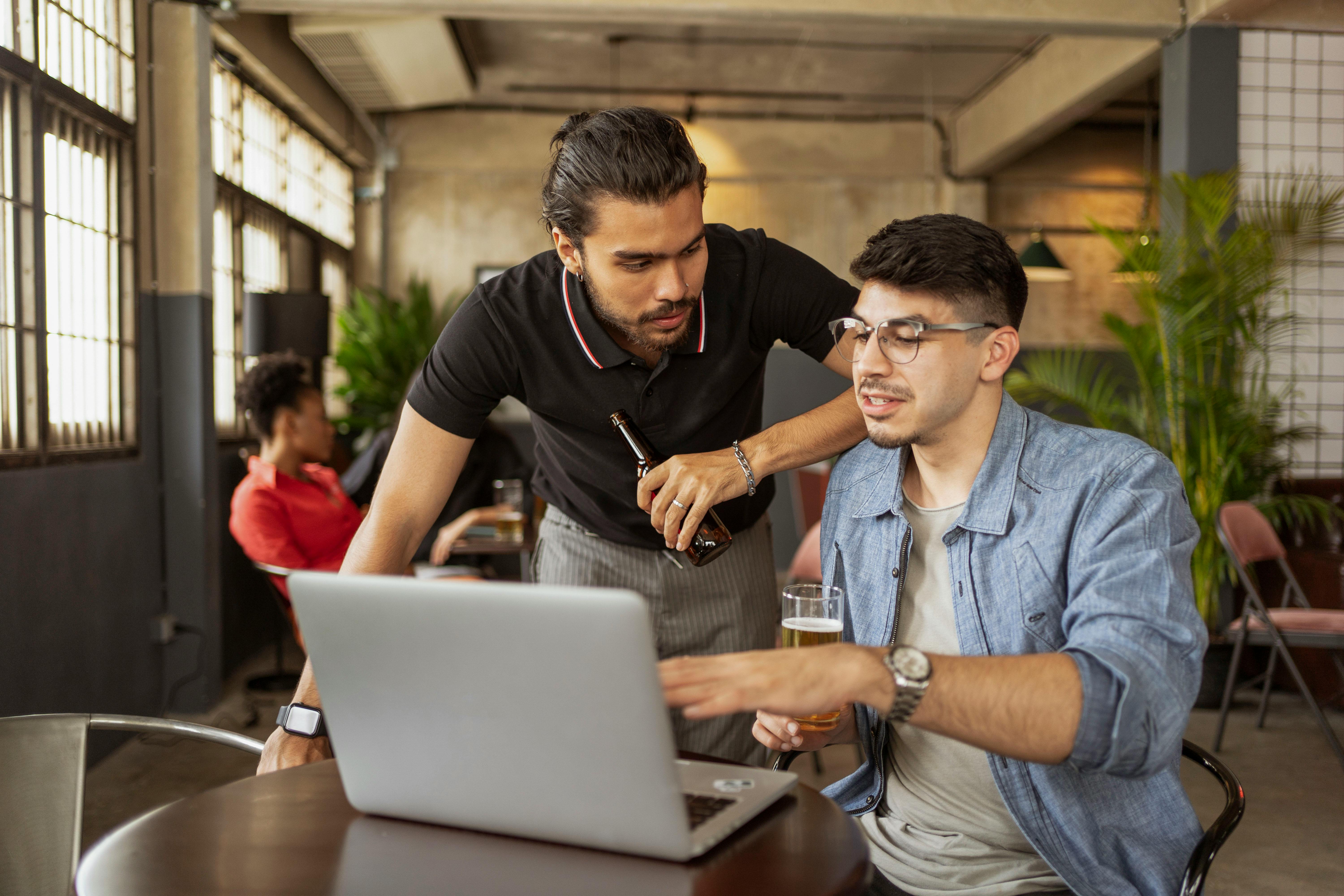 Two Men Looking at a Laptop · Free Stock Photo