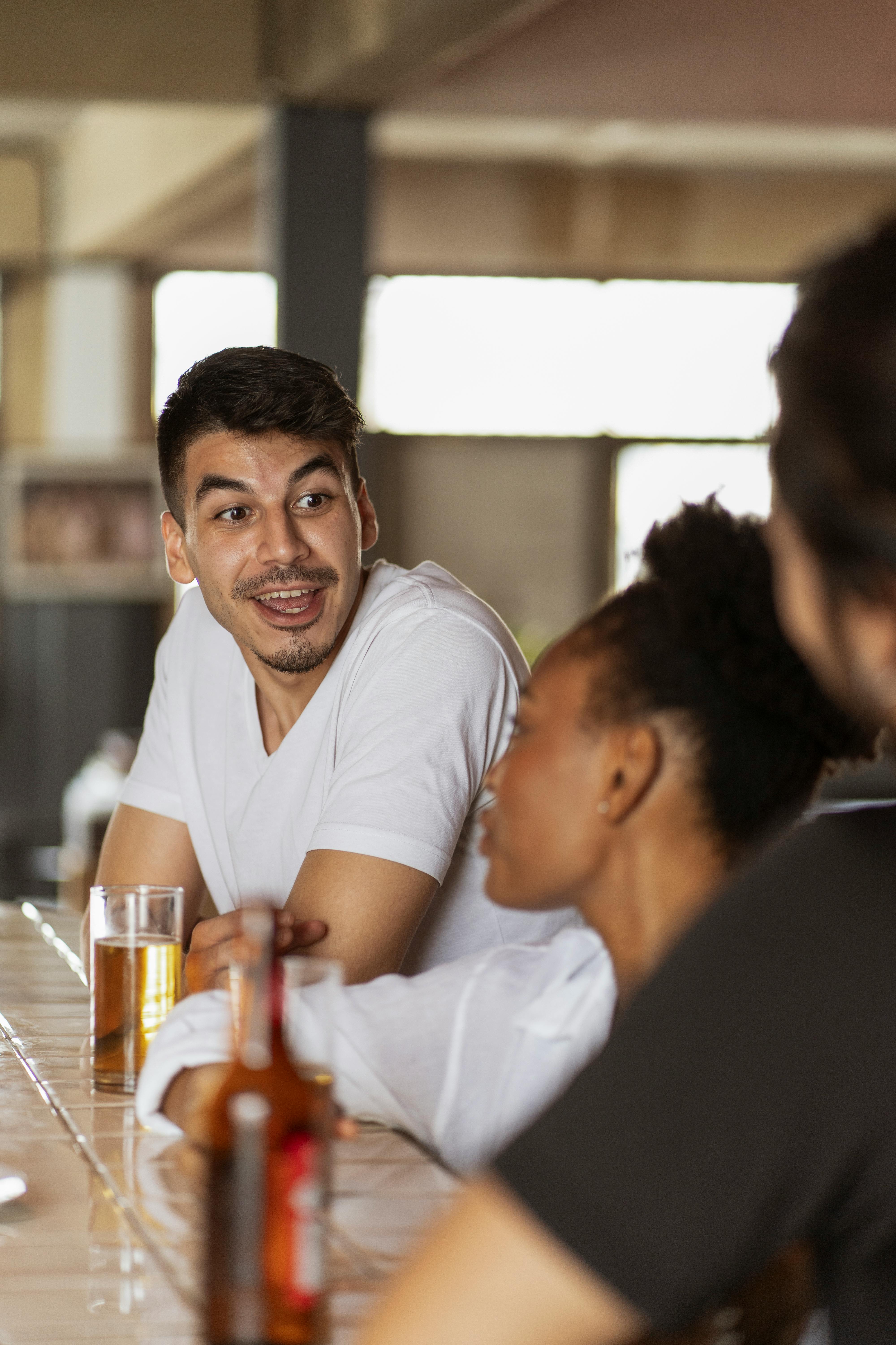 Man and Woman Sitting at Bar Counter · Free Stock Photo