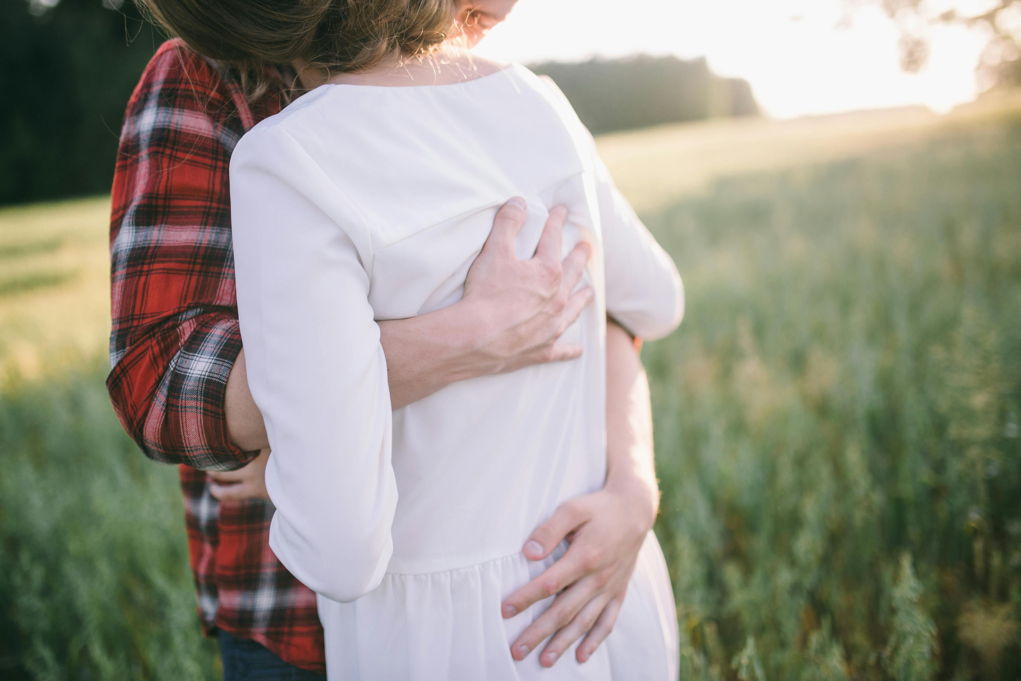 Husband Hugging Wife with Affection · Free Stock Photo