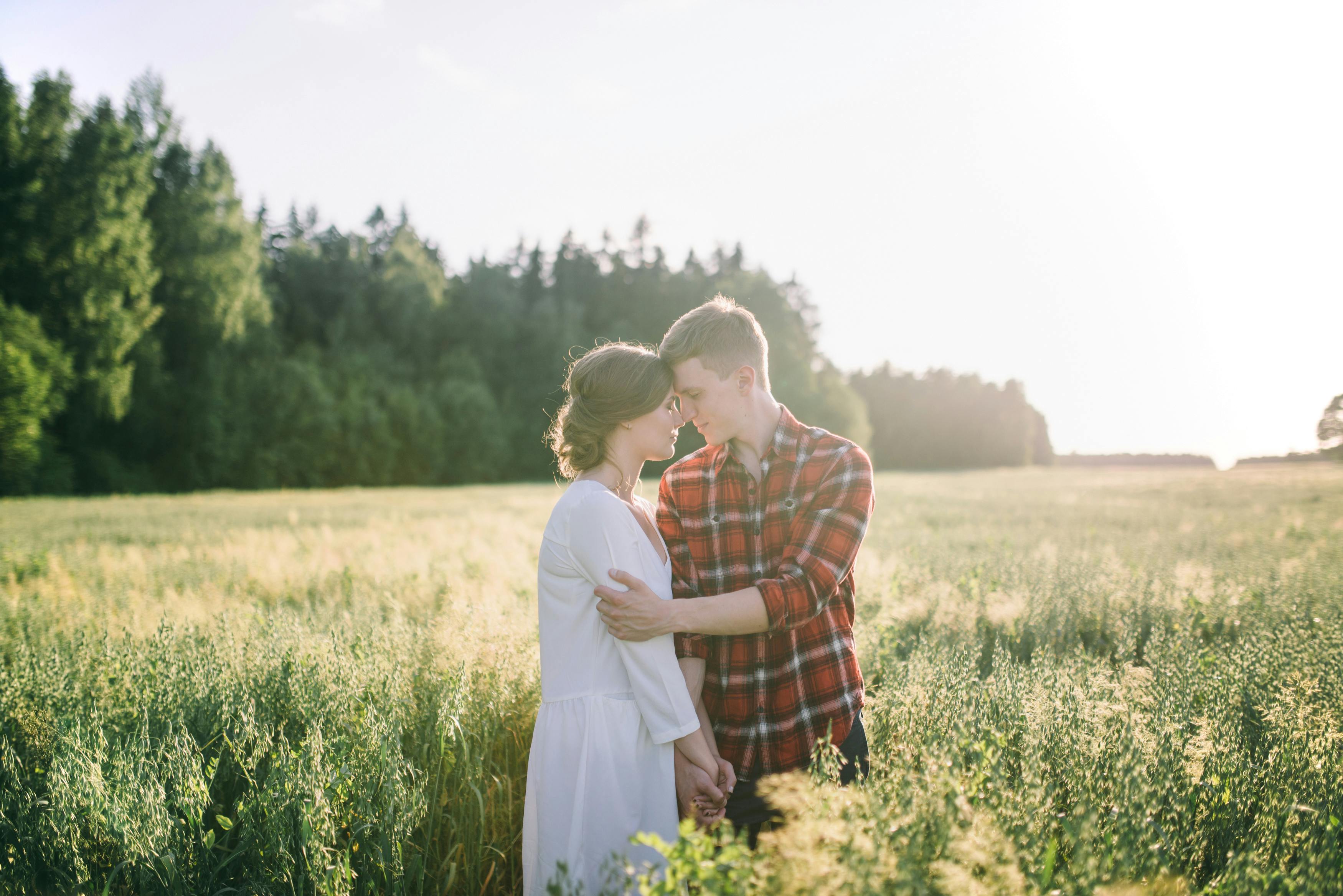 A Couple Hugging in the Field · Free Stock Photo