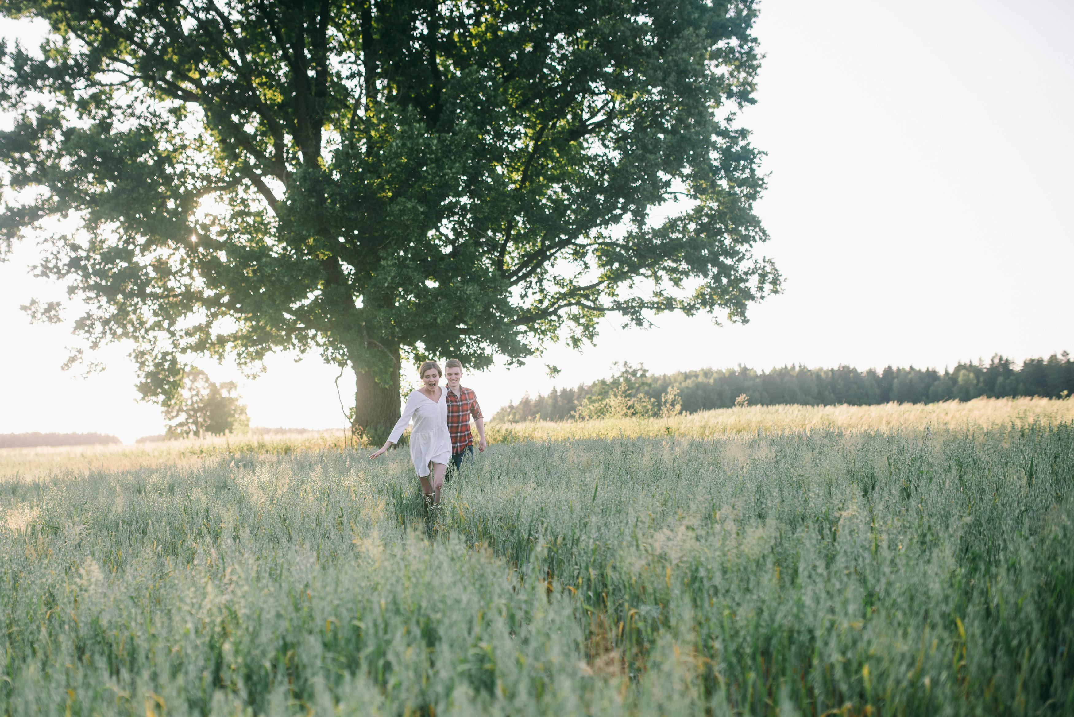 A Couple Running in the Farm Field · Free Stock Photo