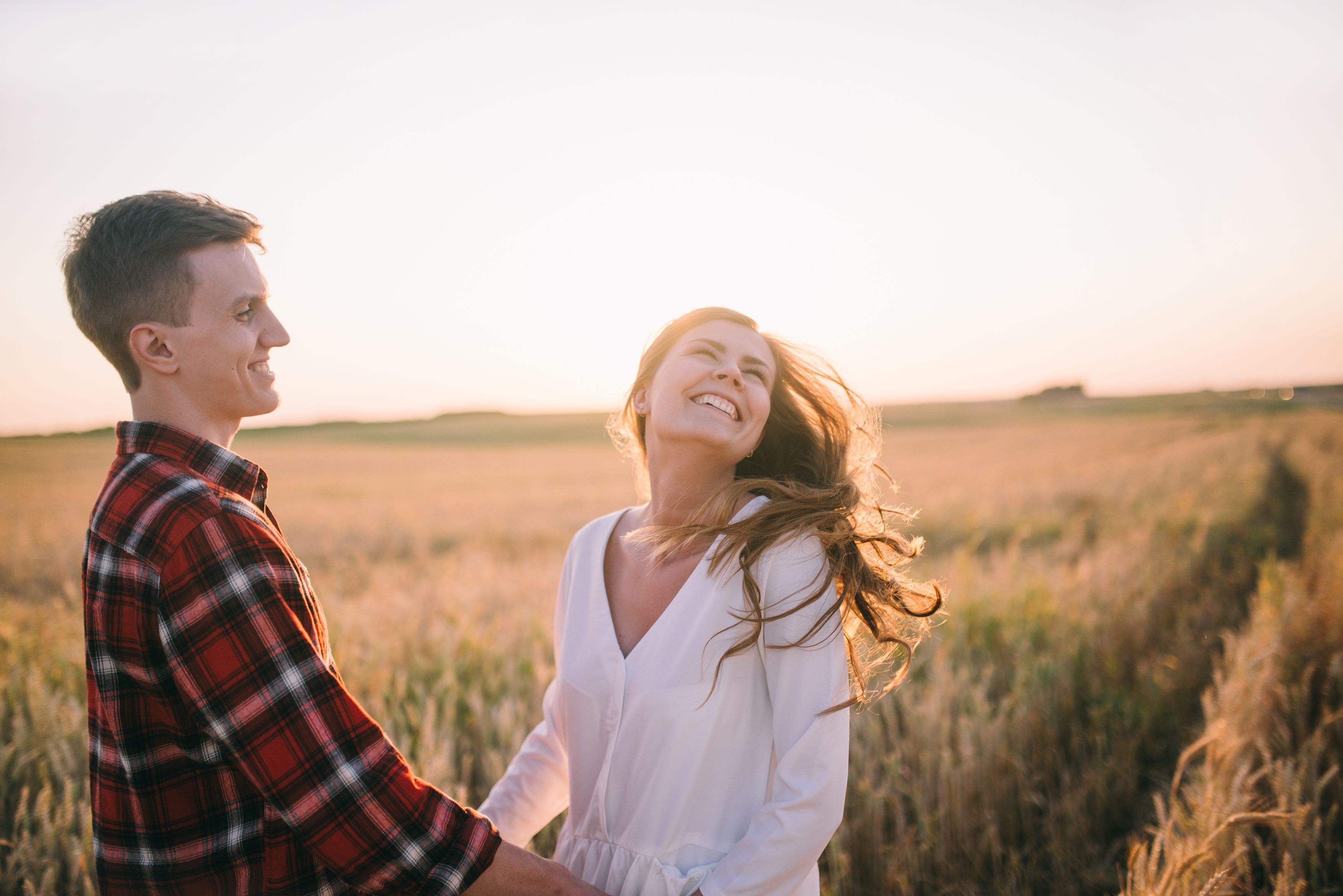A Man Lifting a Woman over His Shoulder · Free Stock Photo