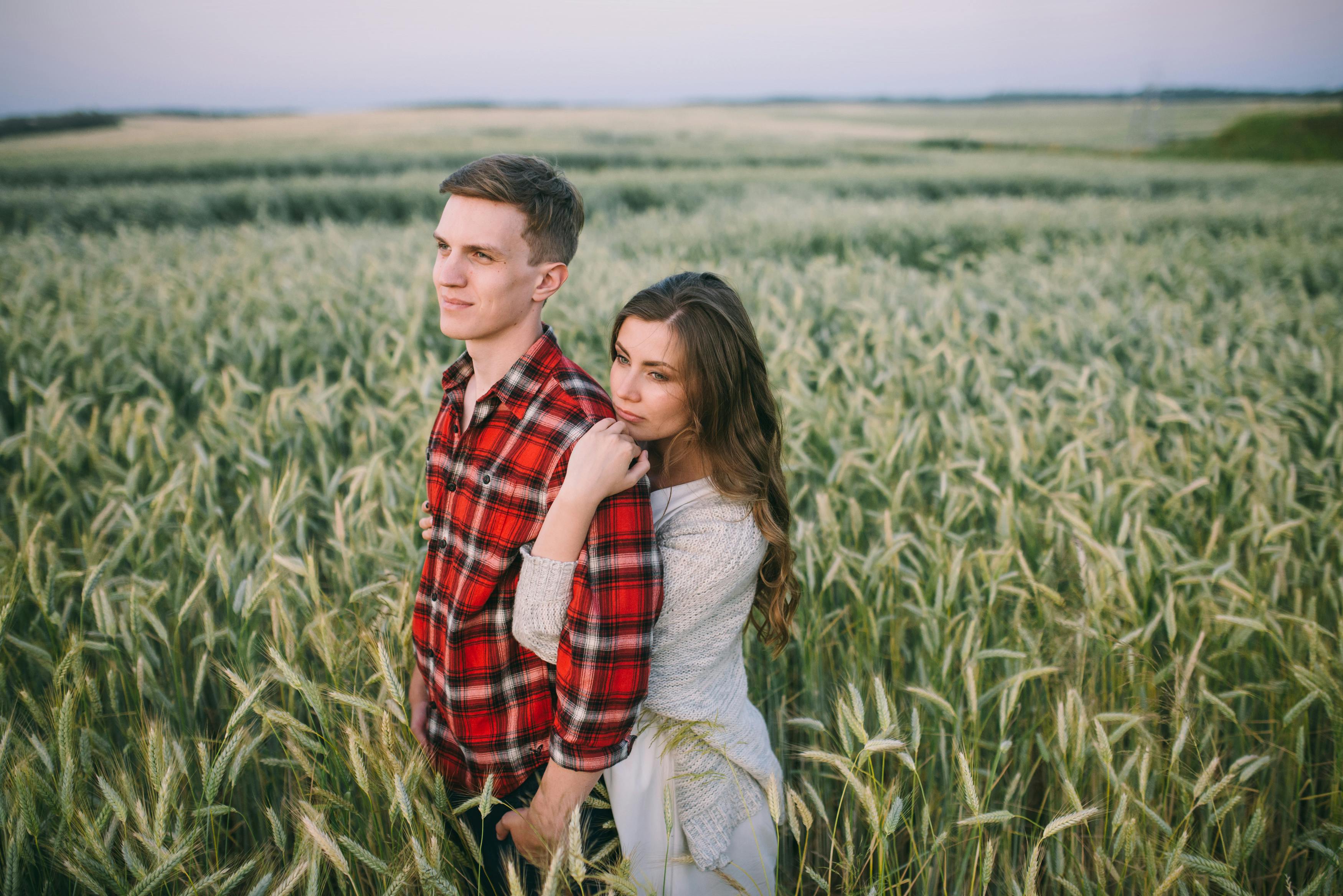 A Couple Hugging in the Field at Sunset · Free Stock Photo