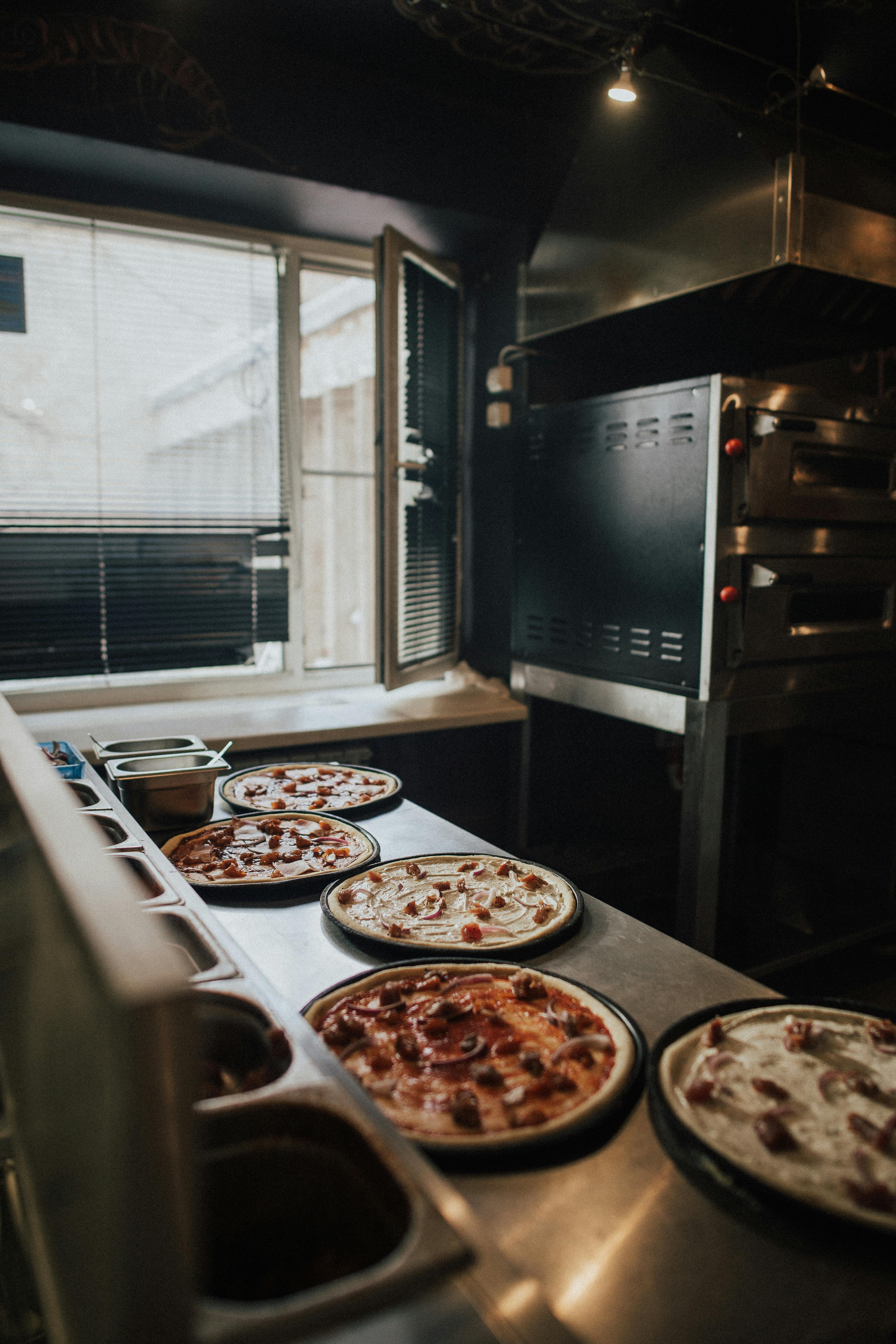 Pizza in Kitchen in Pizzeria · Free Stock Photo