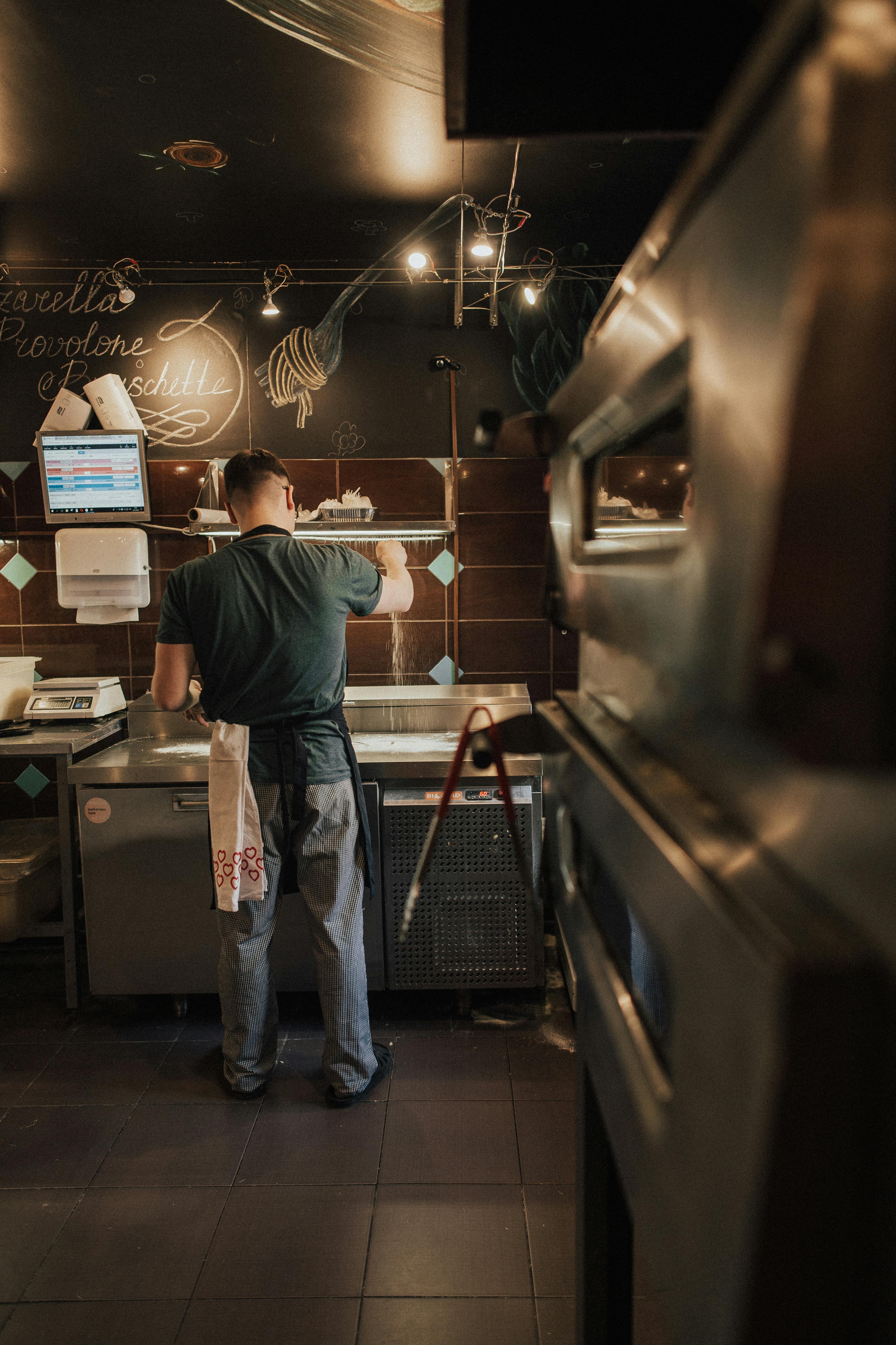 Man Standing Beside a Kitchen Counter · Free Stock Photo