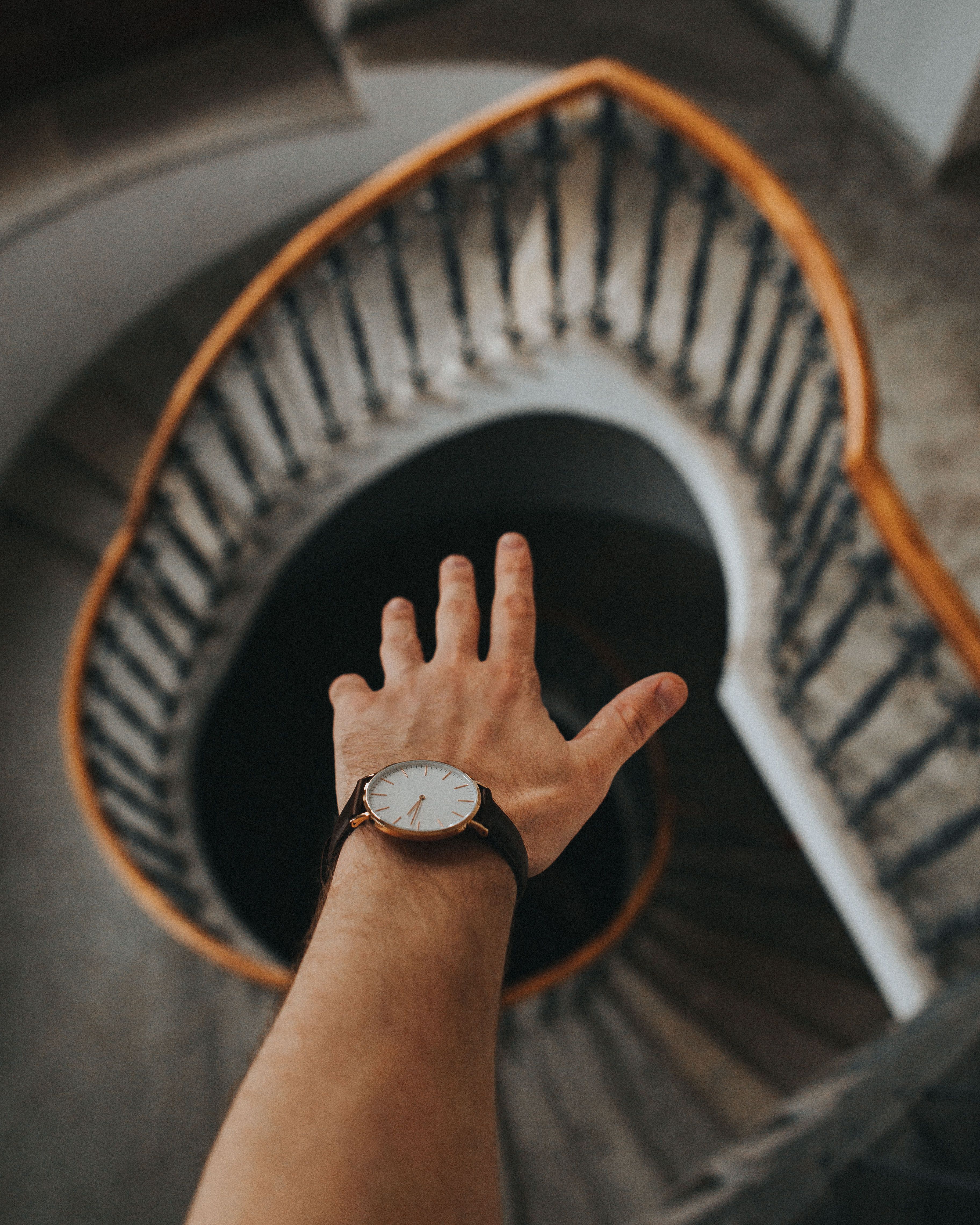 Hand Wearing Round Analog Watch on Staircase · Free Stock Photo