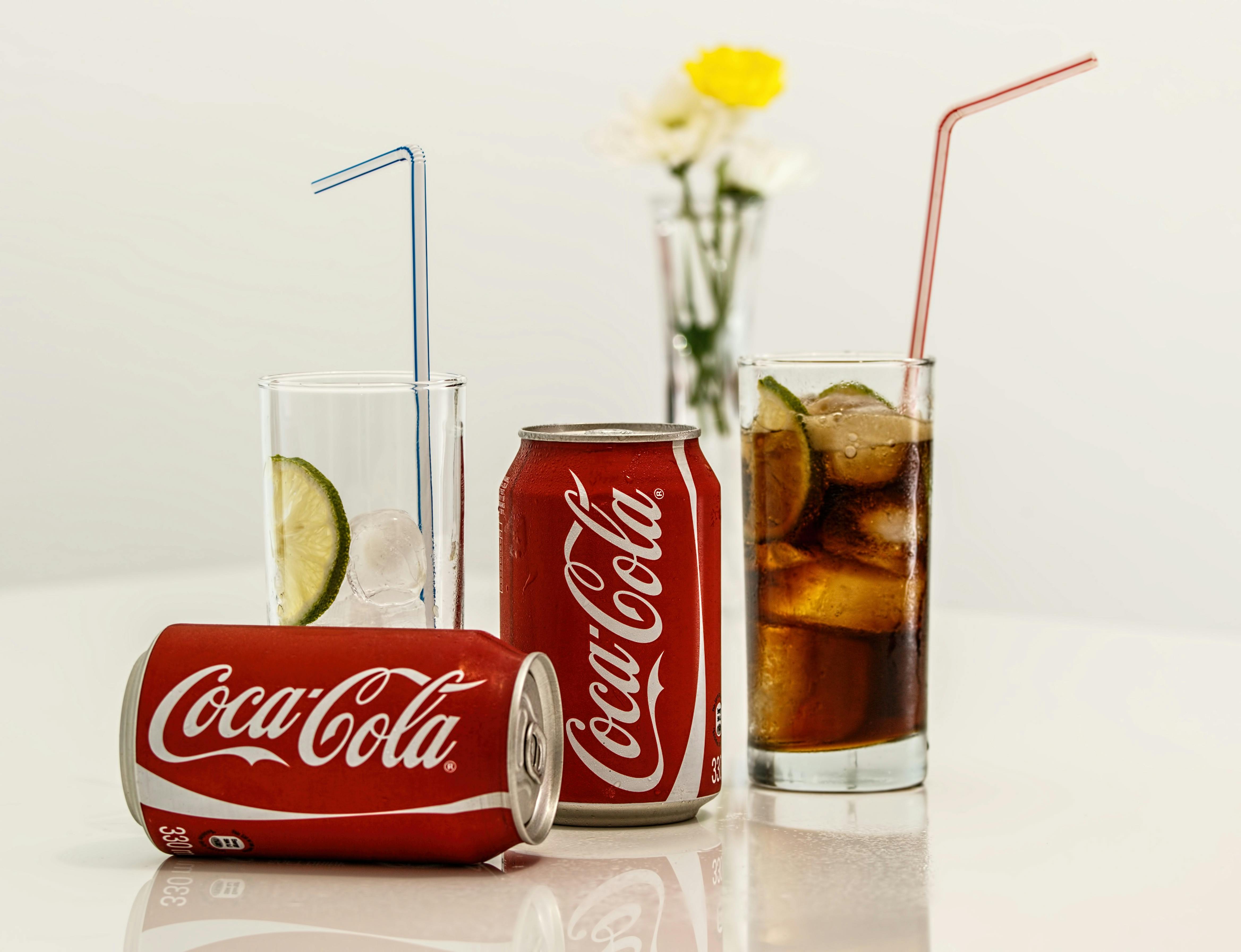 Coca Cola Cans and Glasses With Lines · Free Stock Photo