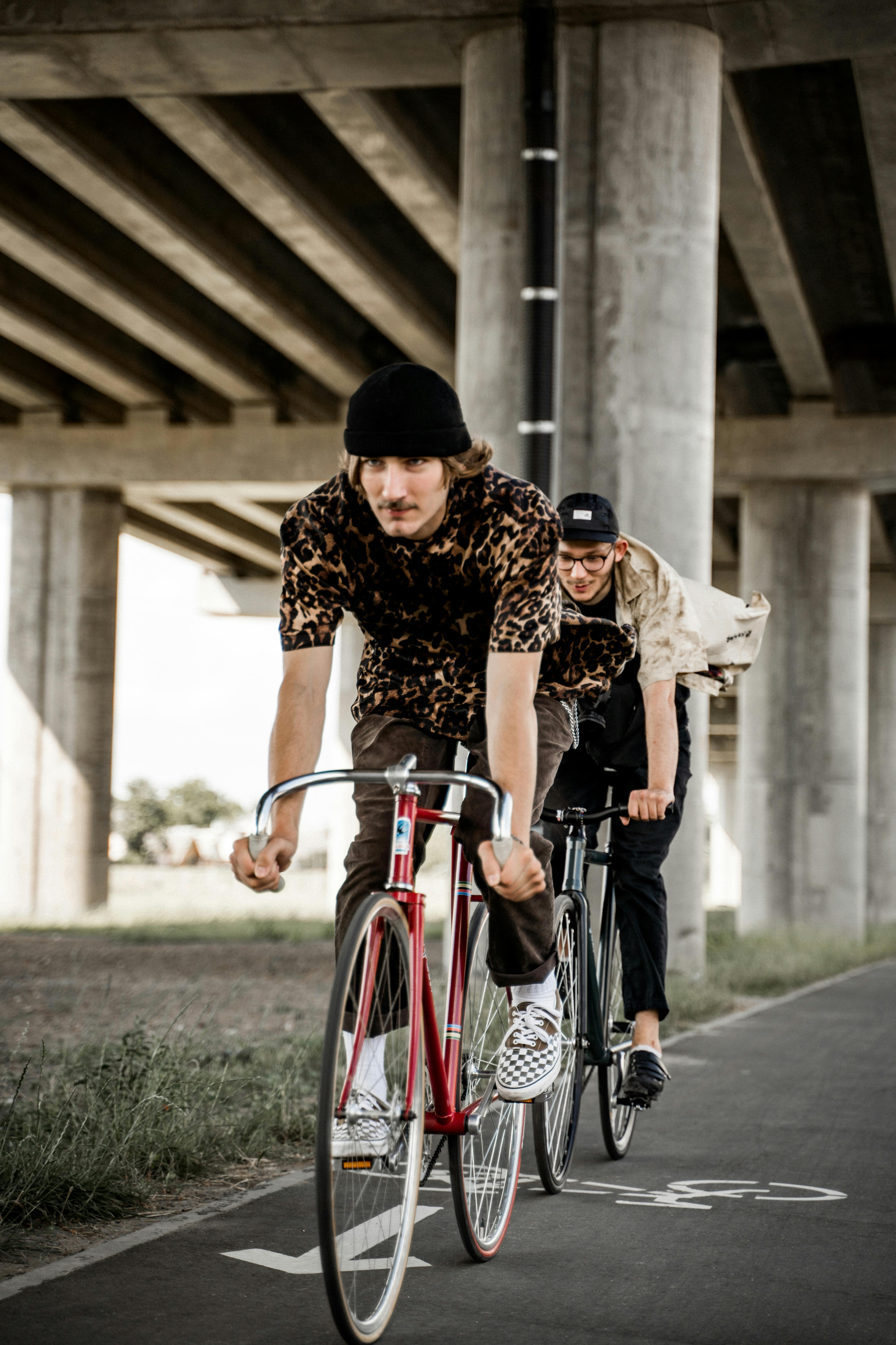 Men Riding on a Bike Touring on the Road · Free Stock Photo