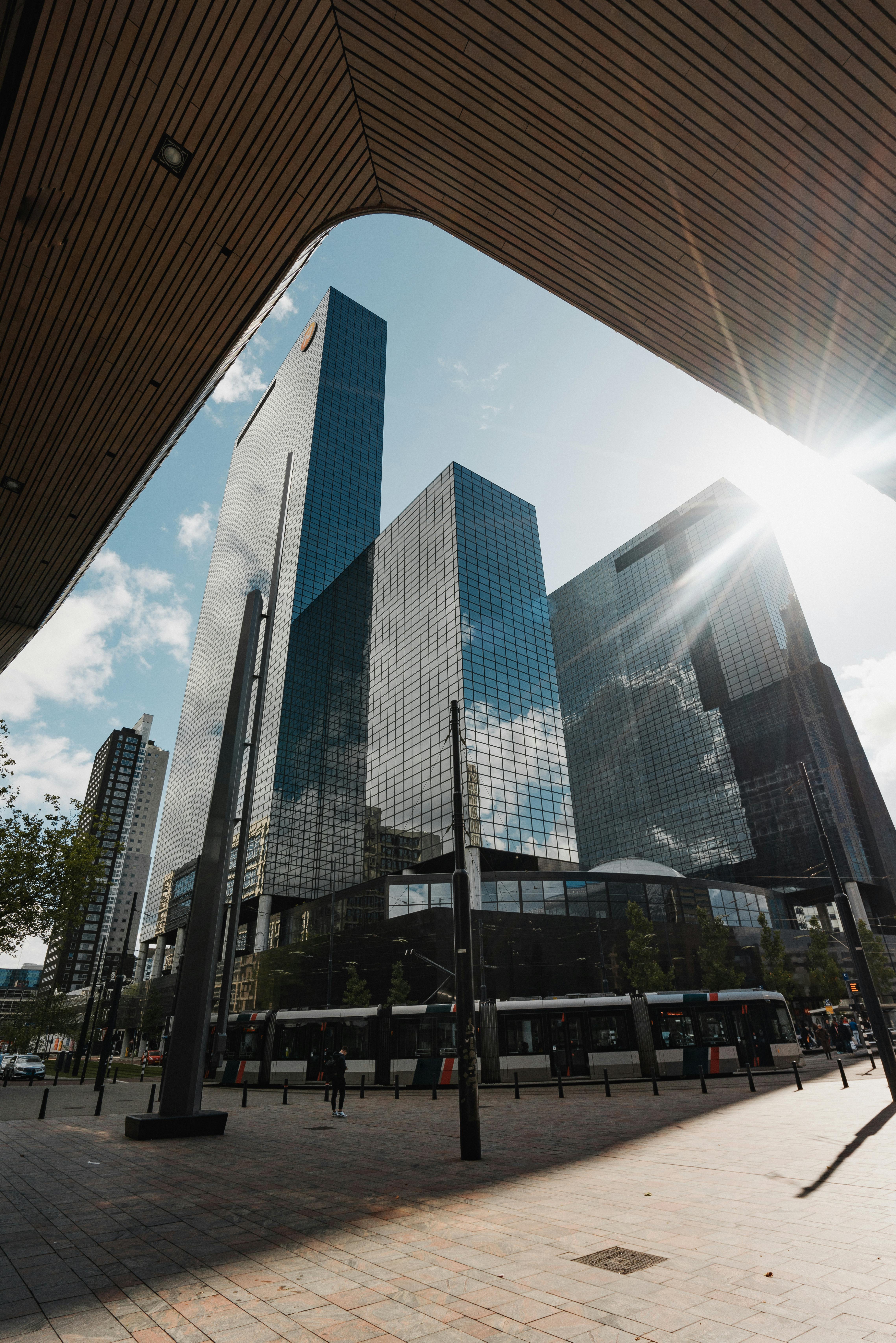 Glass Walled High Rise Buildings Under Sunny Sky · Free Stock Photo