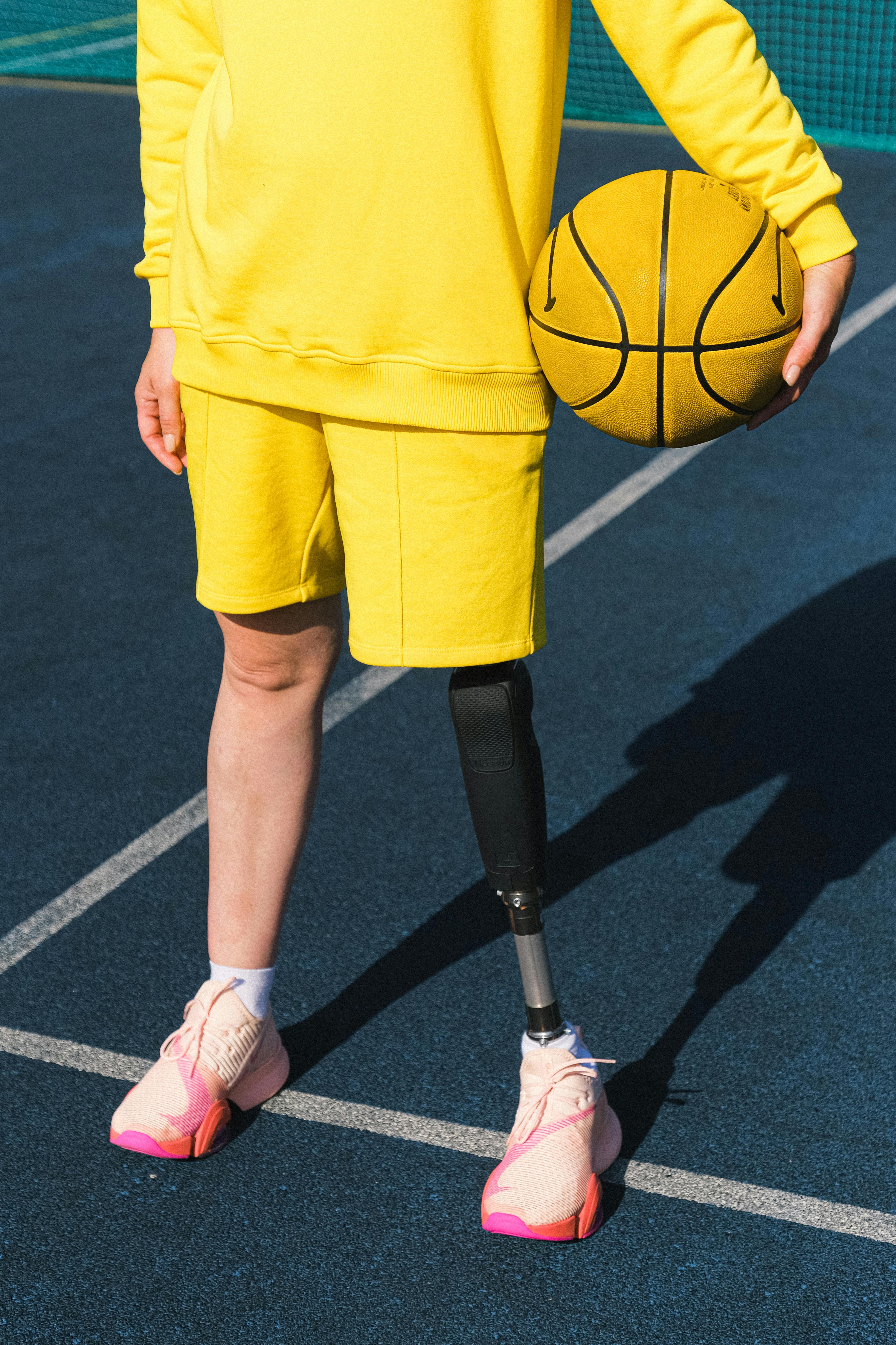 Person with Prostethic Leg and Basketball Ball · Free Stock Photo