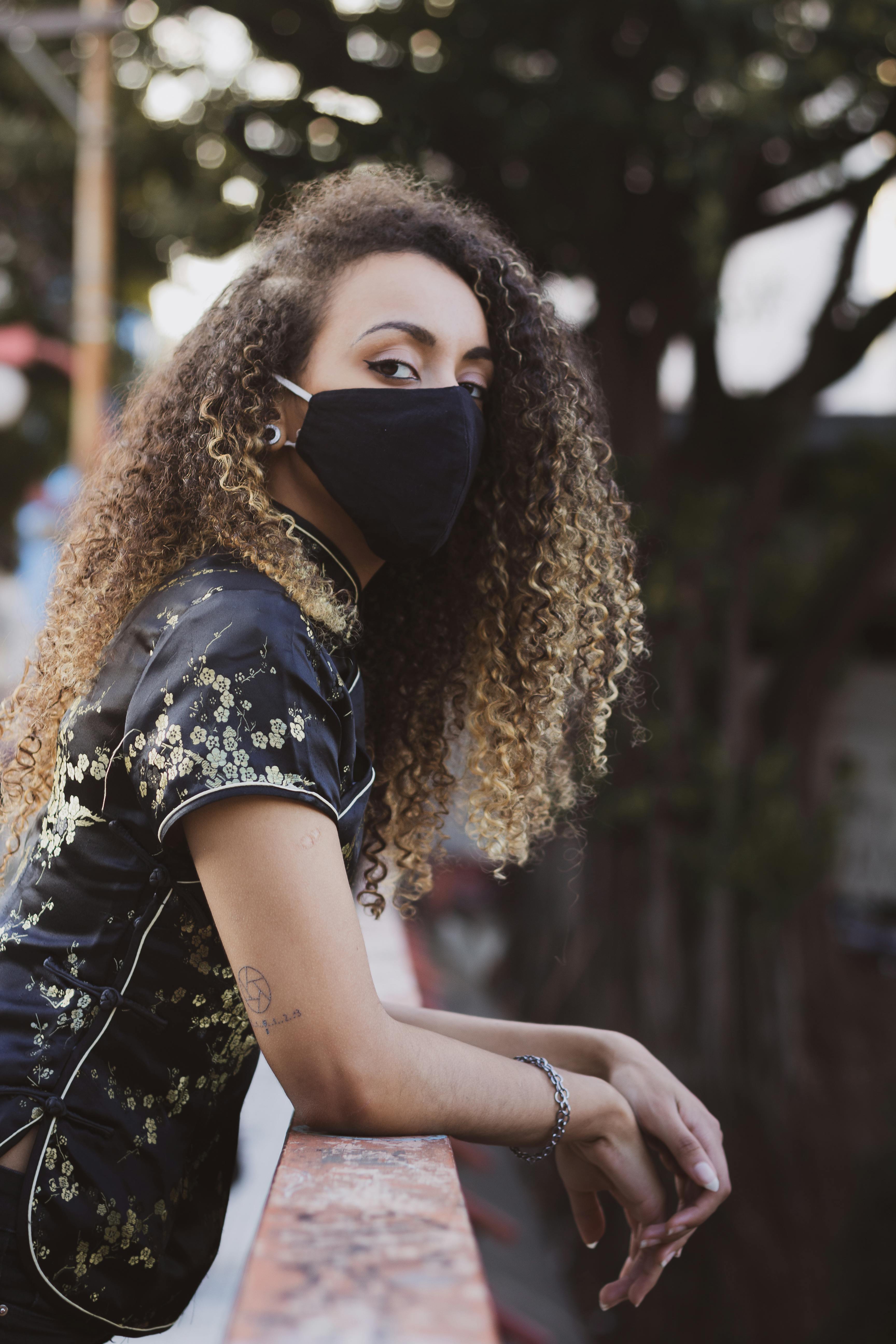 Young Woman removing her Face Mask · Free Stock Photo