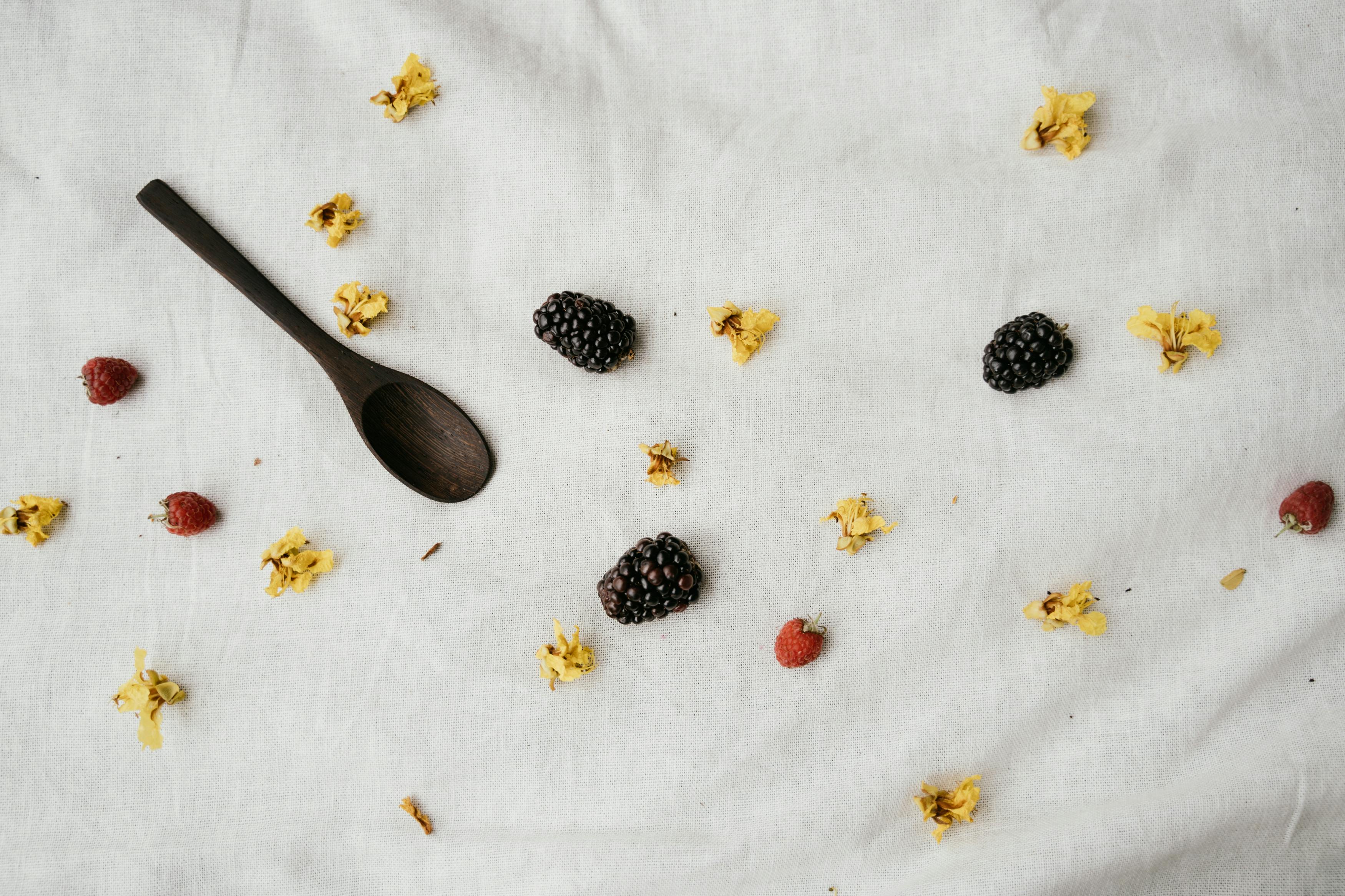 White Textile with Wooden Spoon and Berries · Free Stock Photo