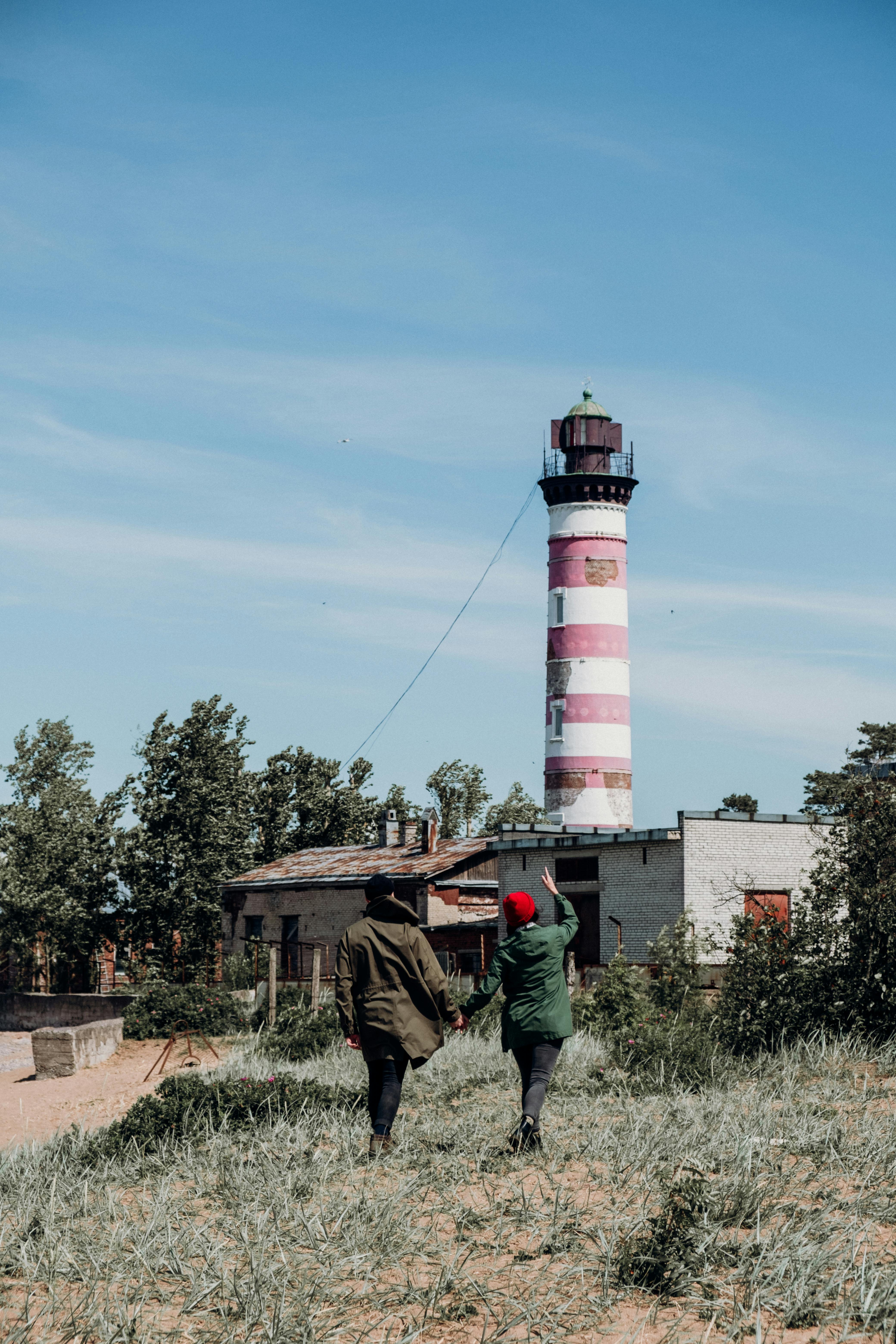 People Walking Towards a Lighthouse · Free Stock Photo