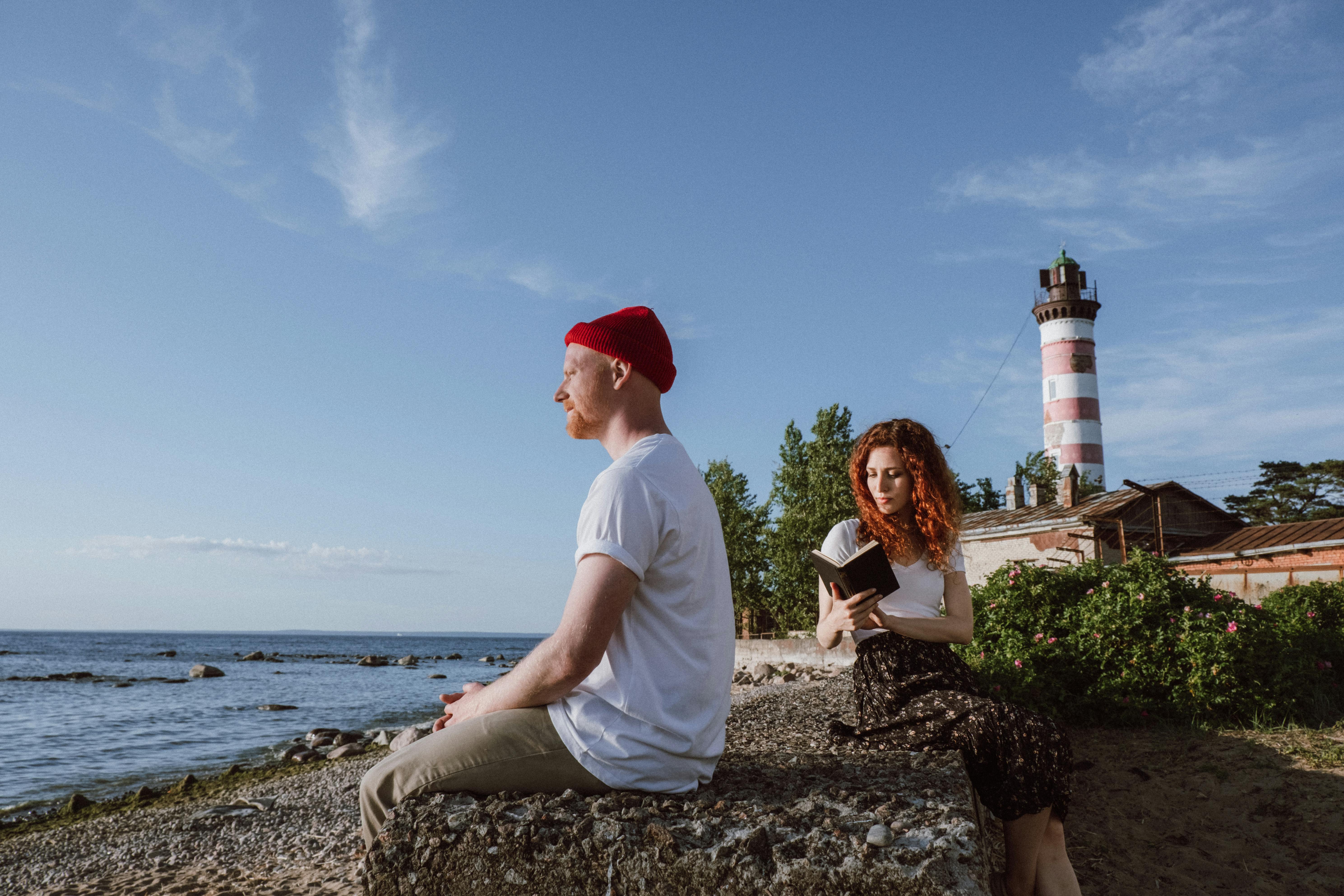 Woman Reading a Book Beside a Man · Free Stock Photo