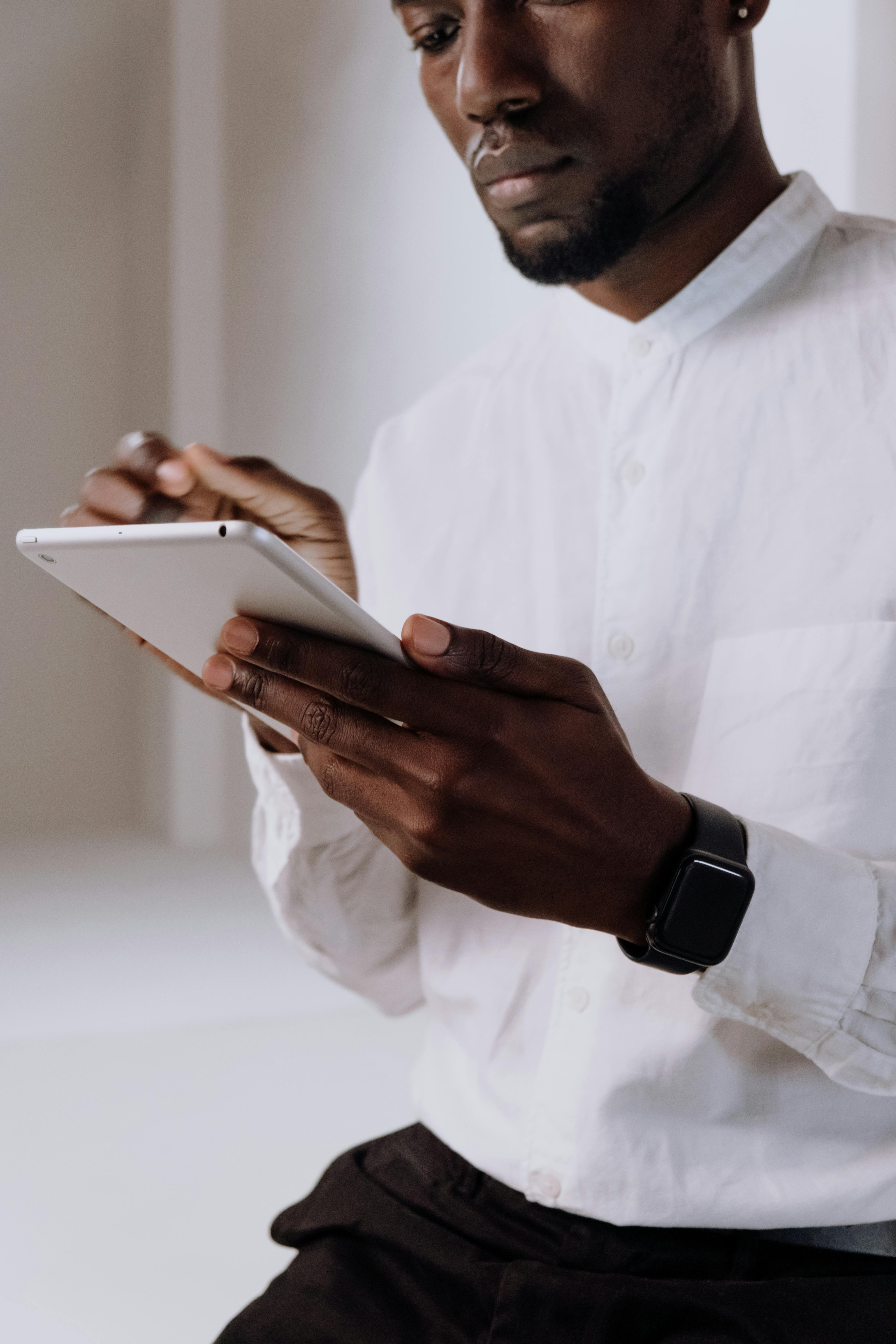 Man in White Dress Shirt Holding White Tablet Computer · Free Stock Photo