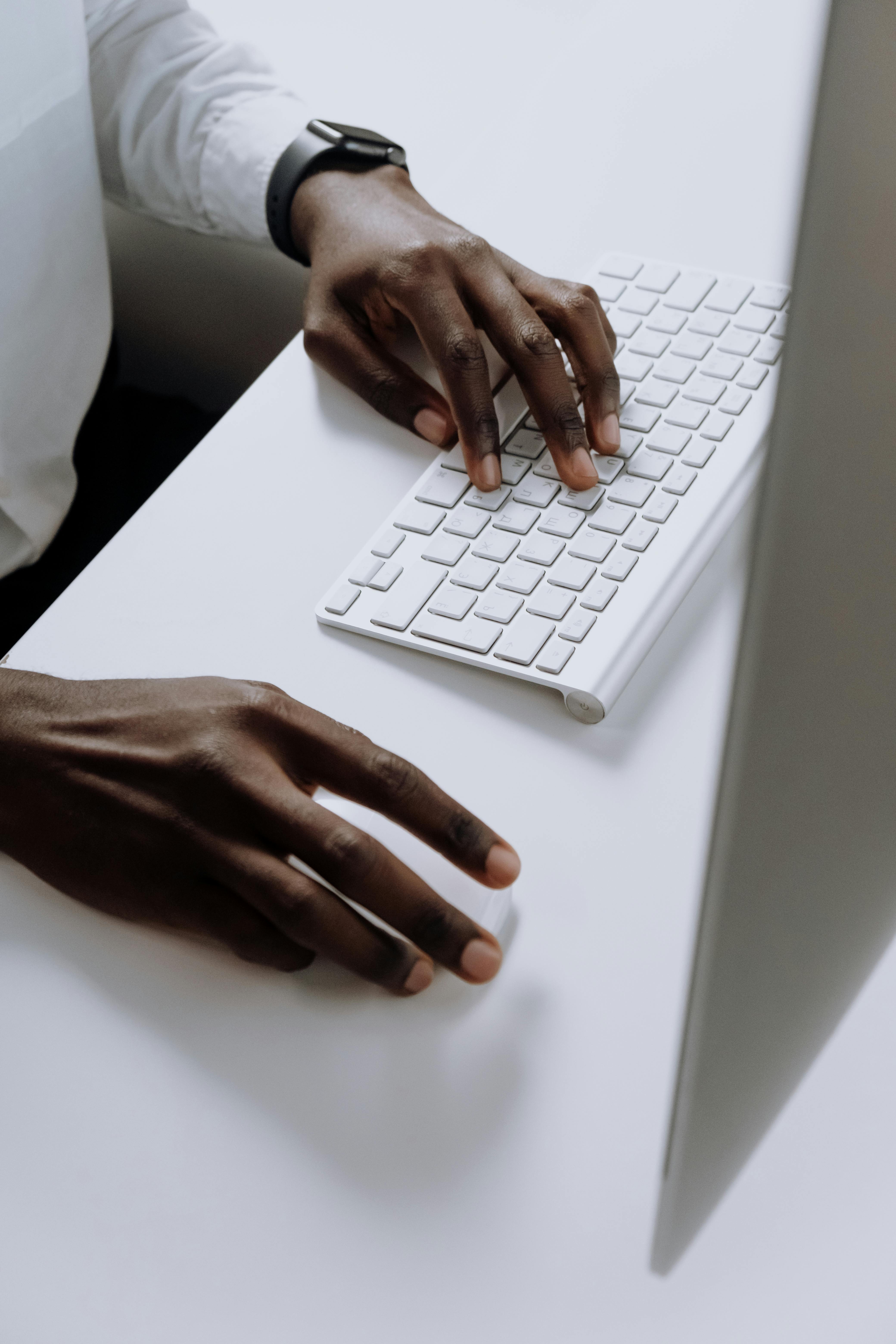 Person Holding White Apple Keyboard · Free Stock Photo
