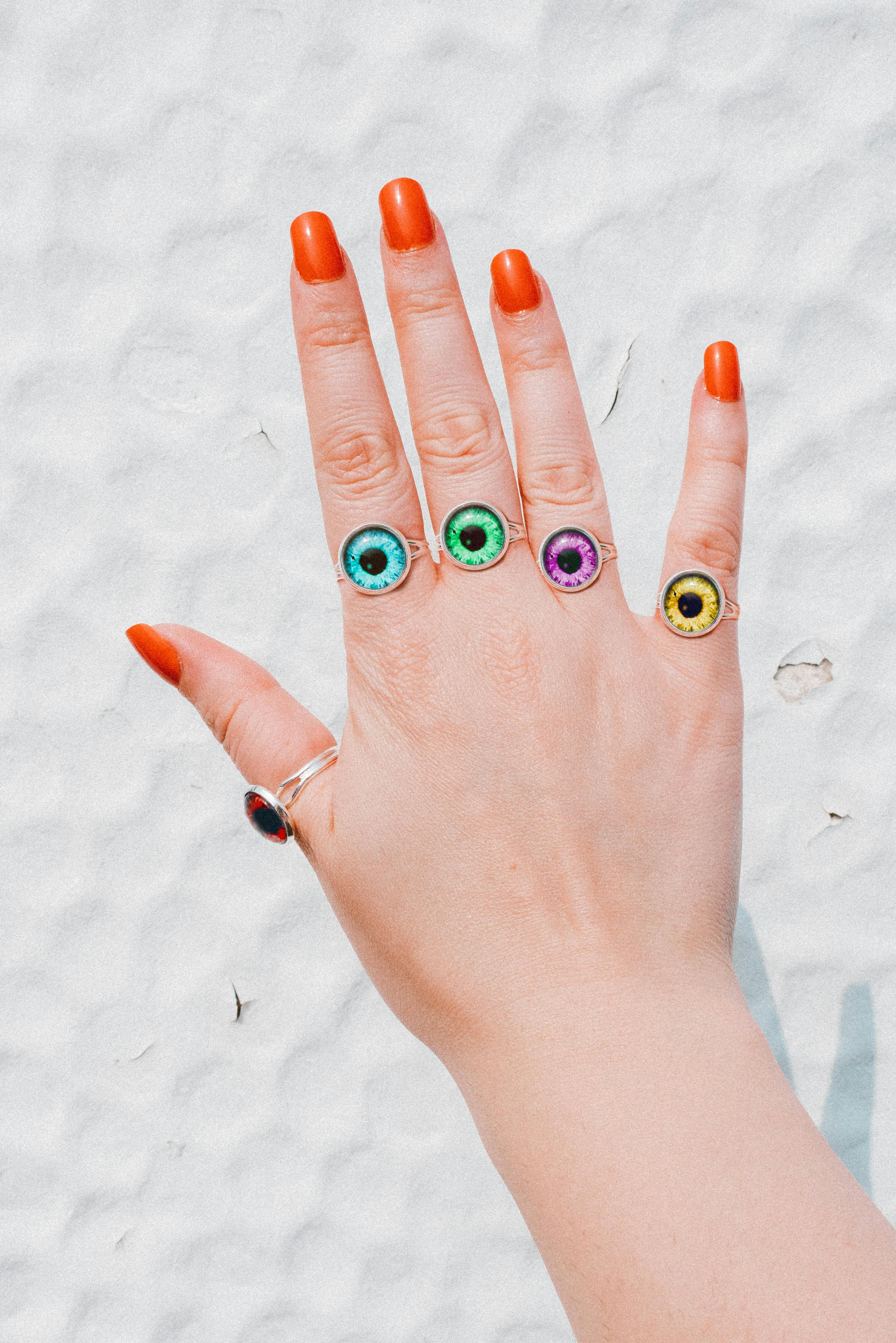 A Woman Hands With Colorful Rings on Each Finger · Free Stock Photo