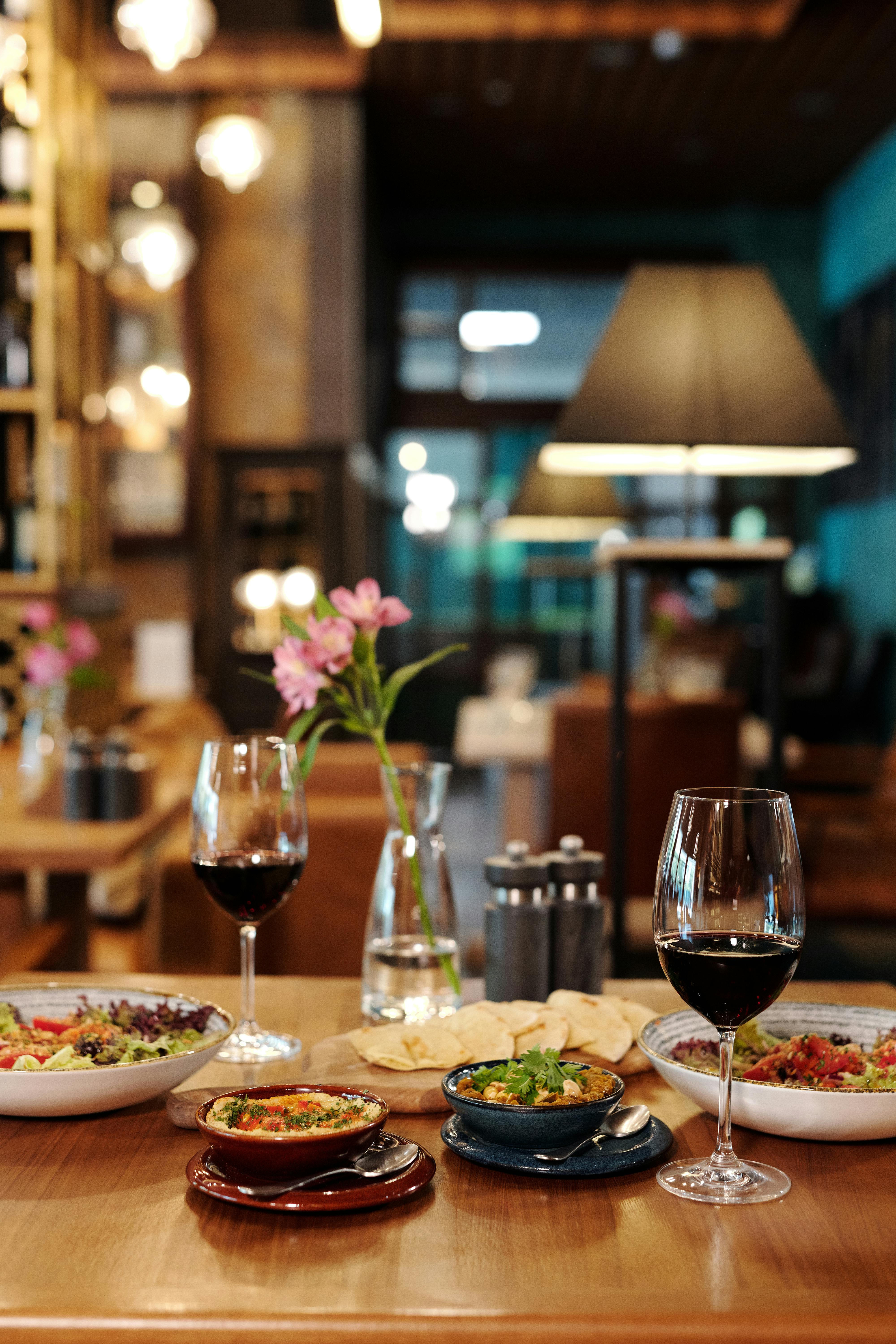 A Wine Glasses and Foods on a Wooden Table · Free Stock Photo