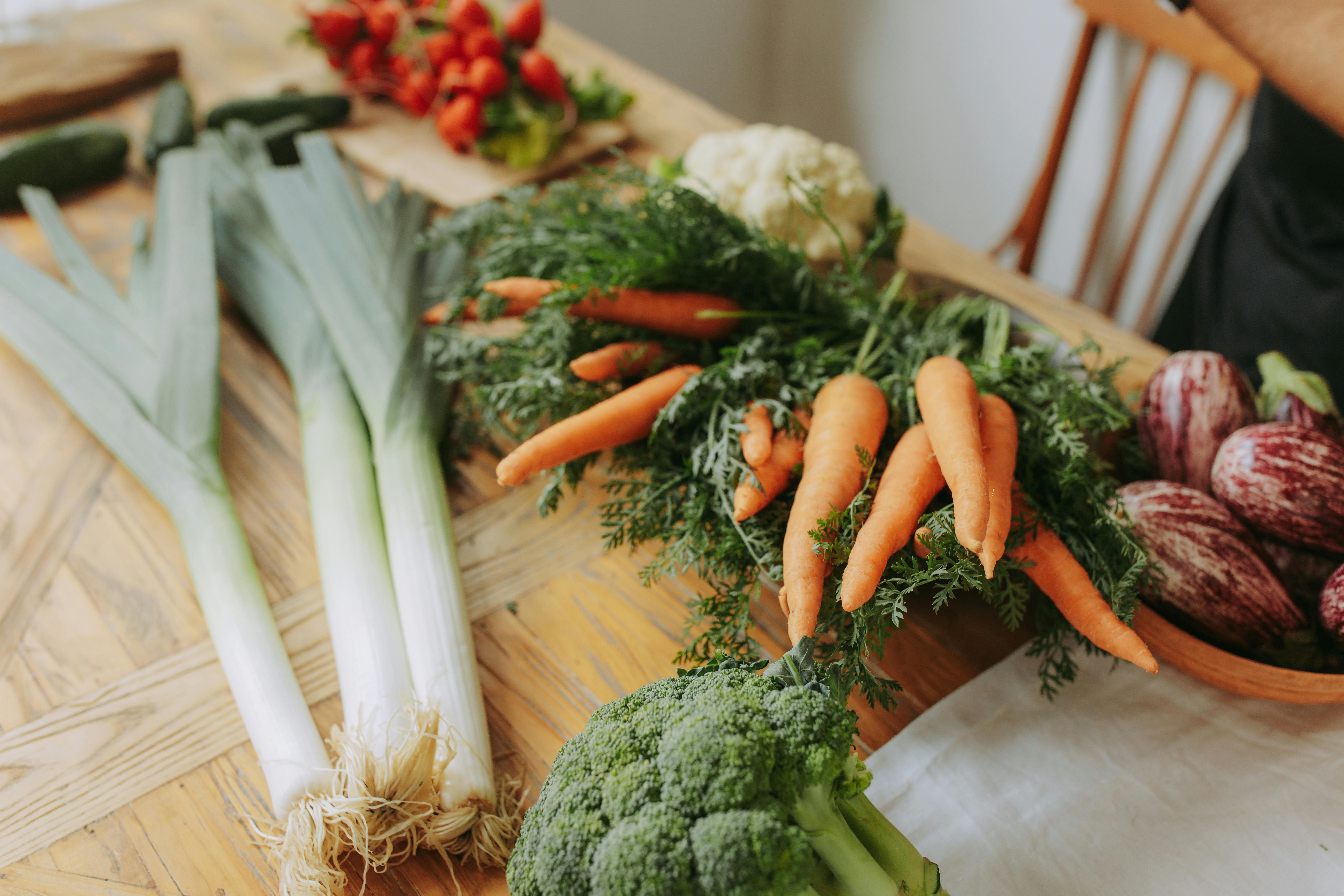 Green Broccoli Vegetable on Brown Wooden Table · Free Stock Photo
