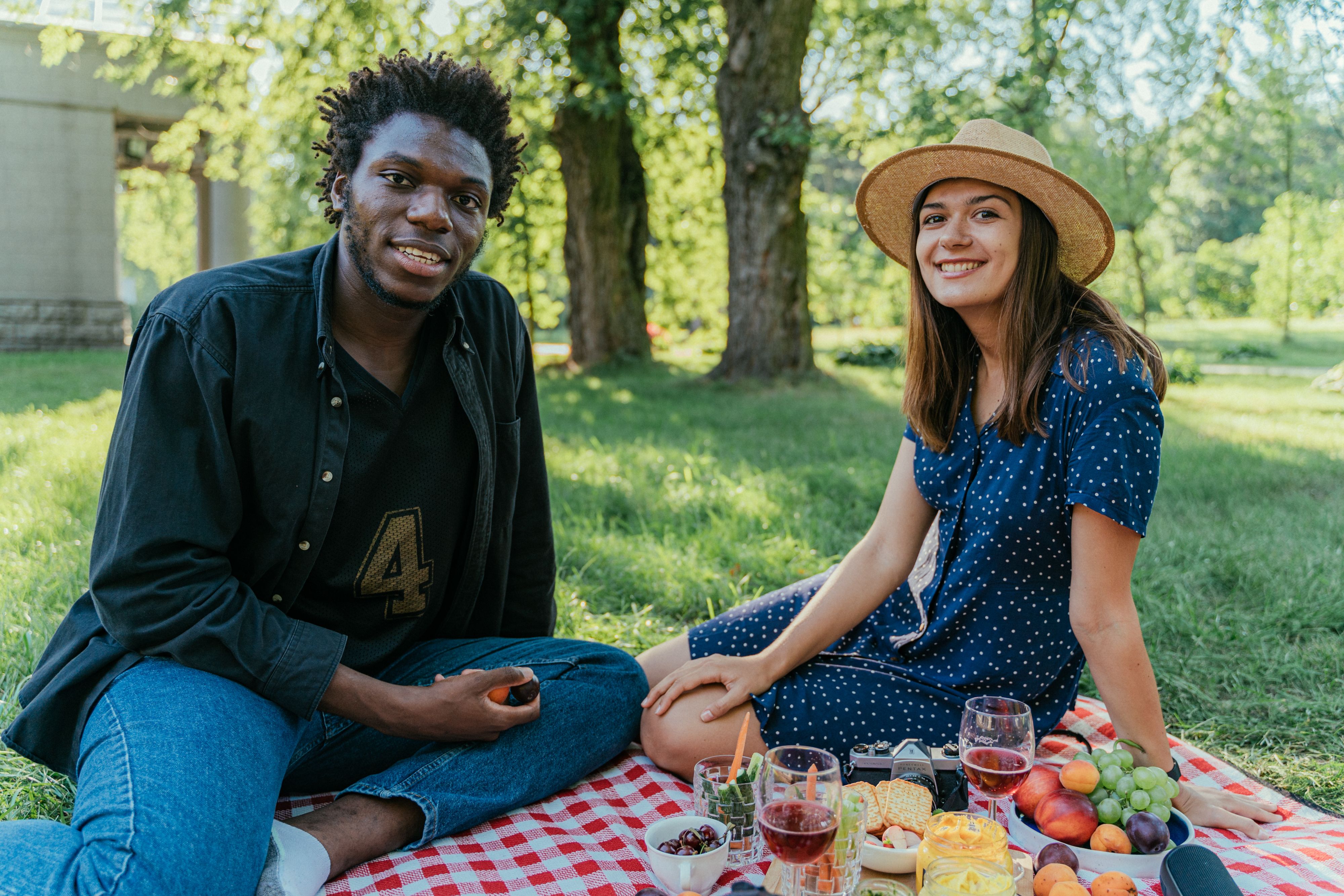 Couple Having Picnic in Meadow at Sunset · Free Stock Photo