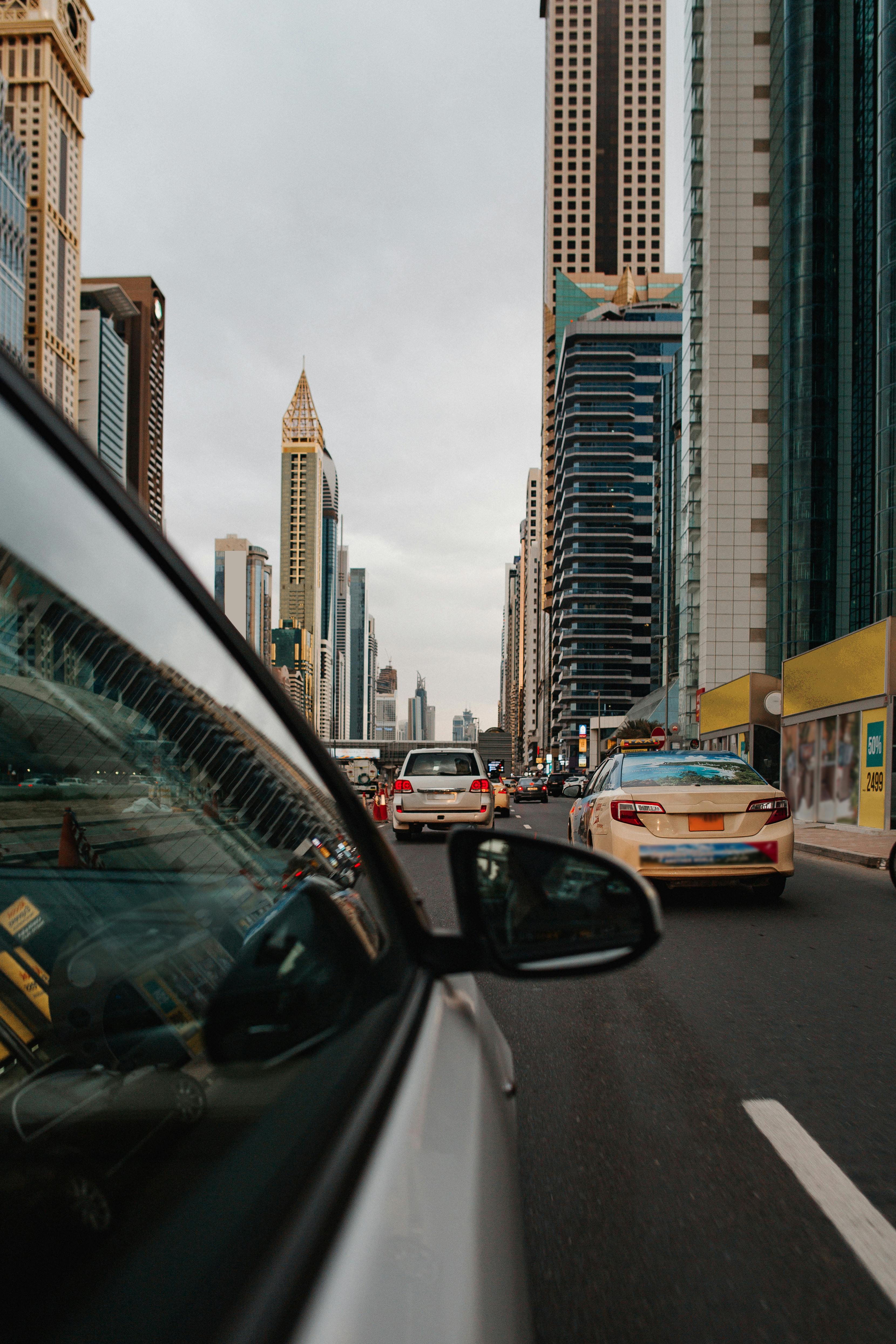 Cars on the Road Near High Rise Buildings · Free Stock Photo