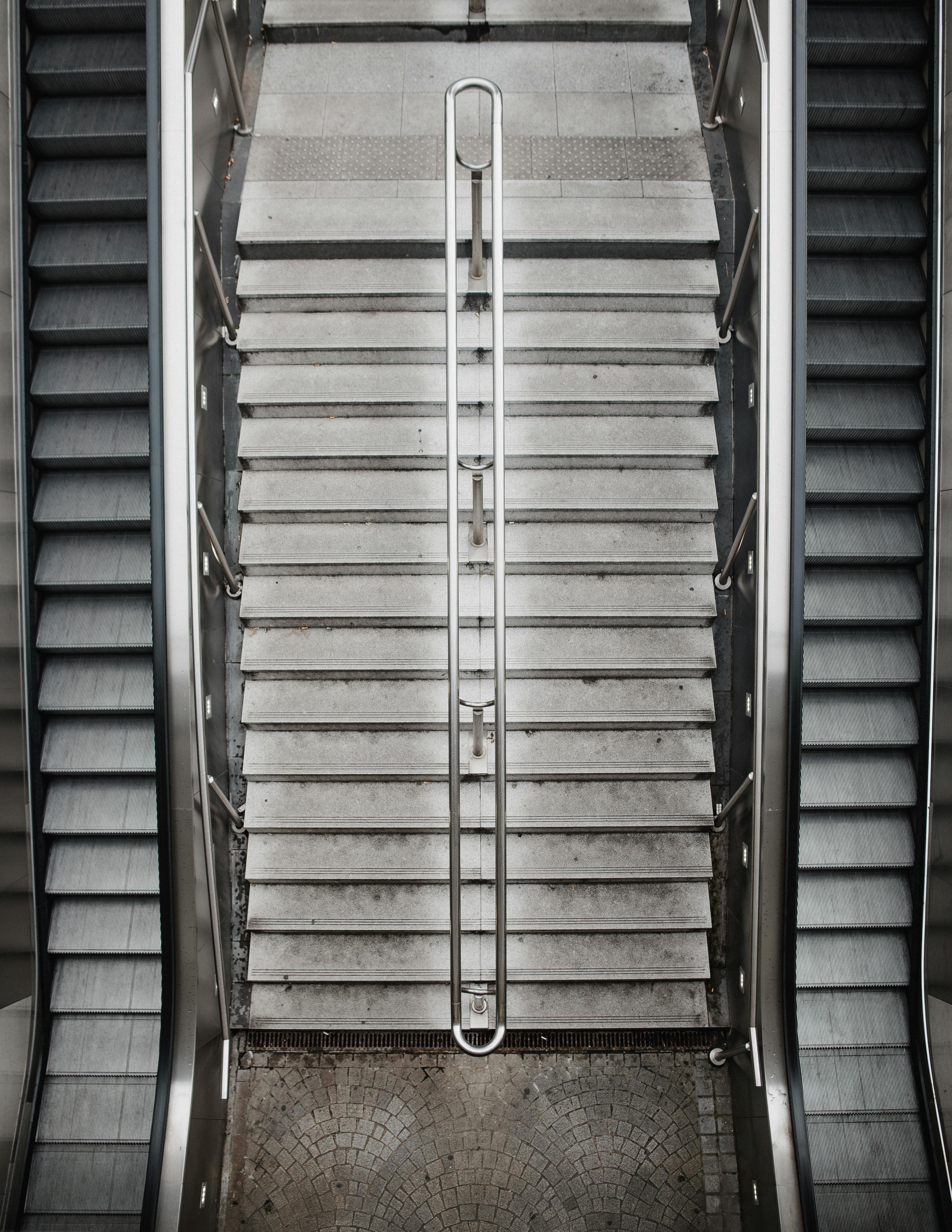 High-Angle Shot of Stairs Between Escalators · Free Stock Photo