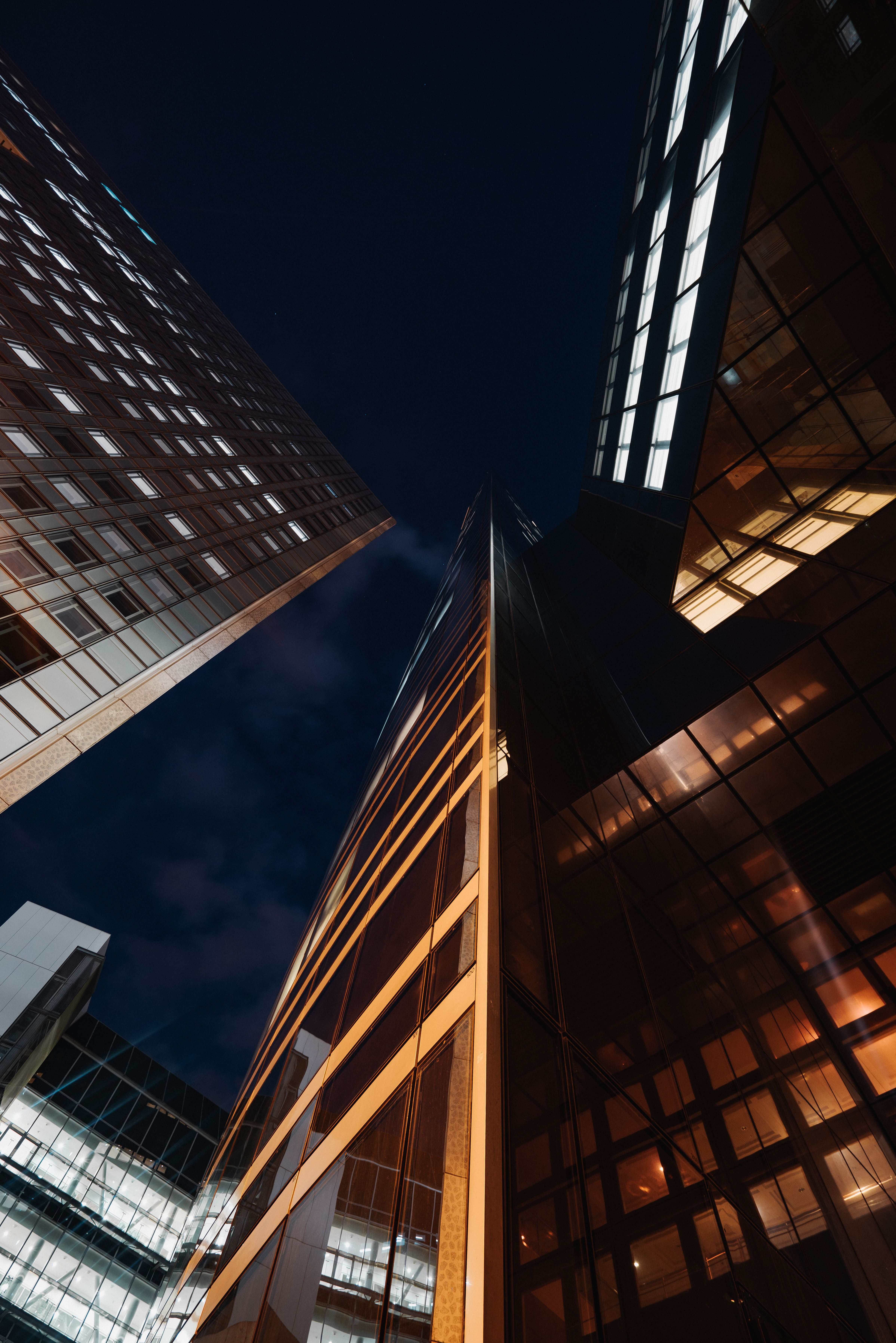 Low Angle Shot of High Rise Buildings at Night · Free Stock Photo