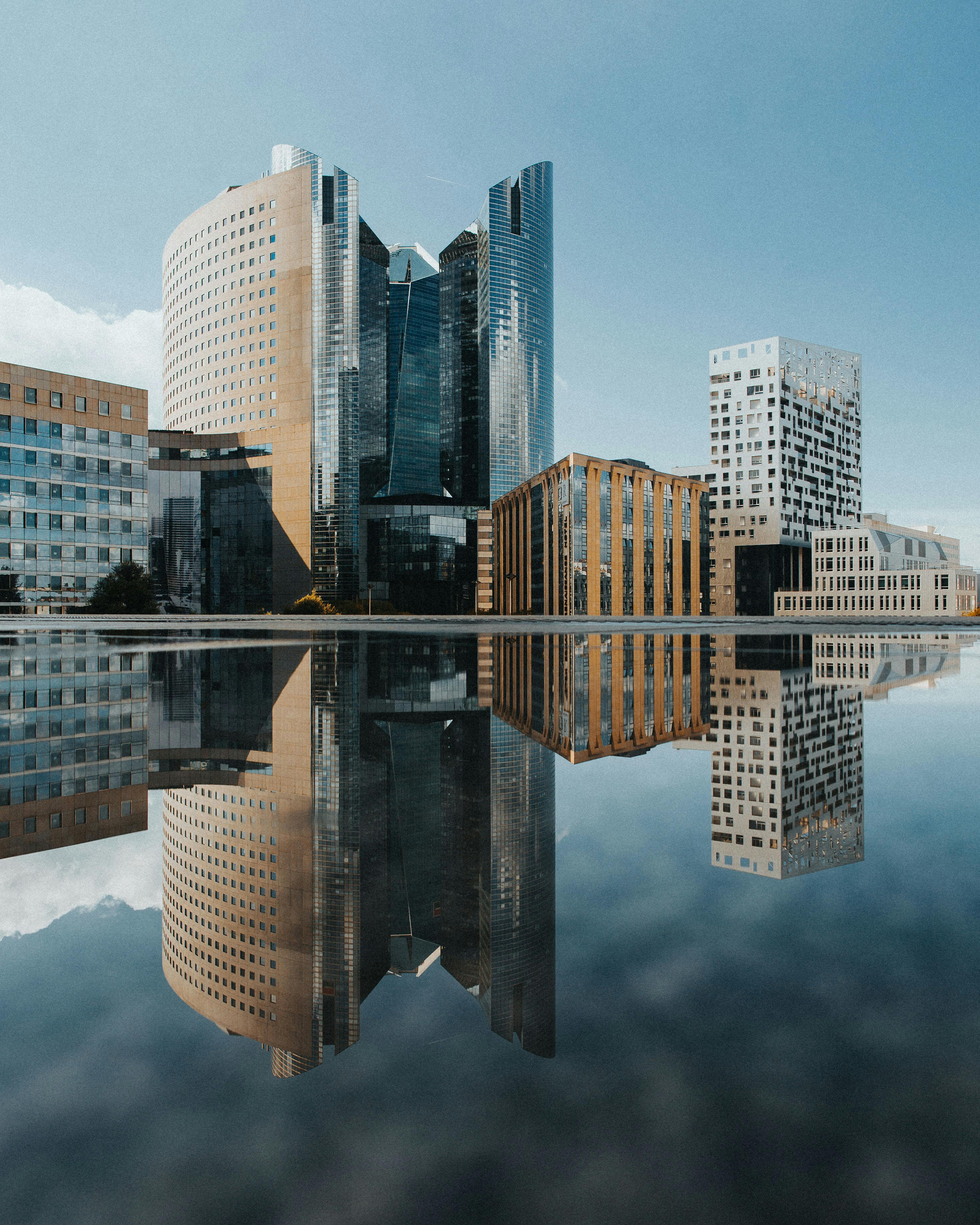 Cityscape Reflection Along the Body of Water · Free Stock Photo
