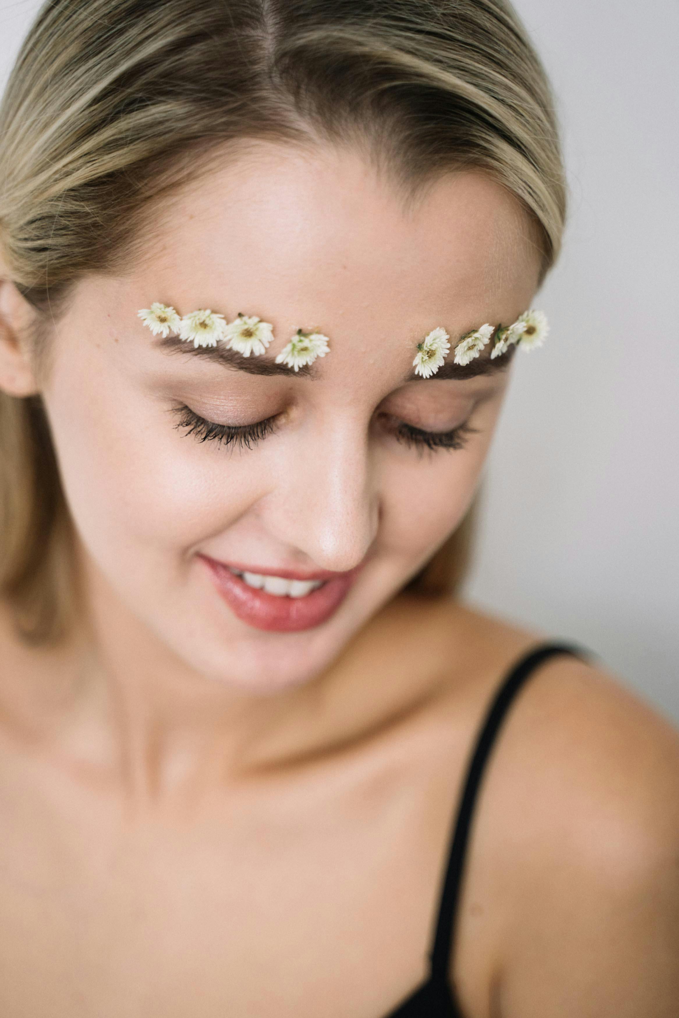 A Woman with Small Flowers Over her Eyebrows · Free Stock Photo