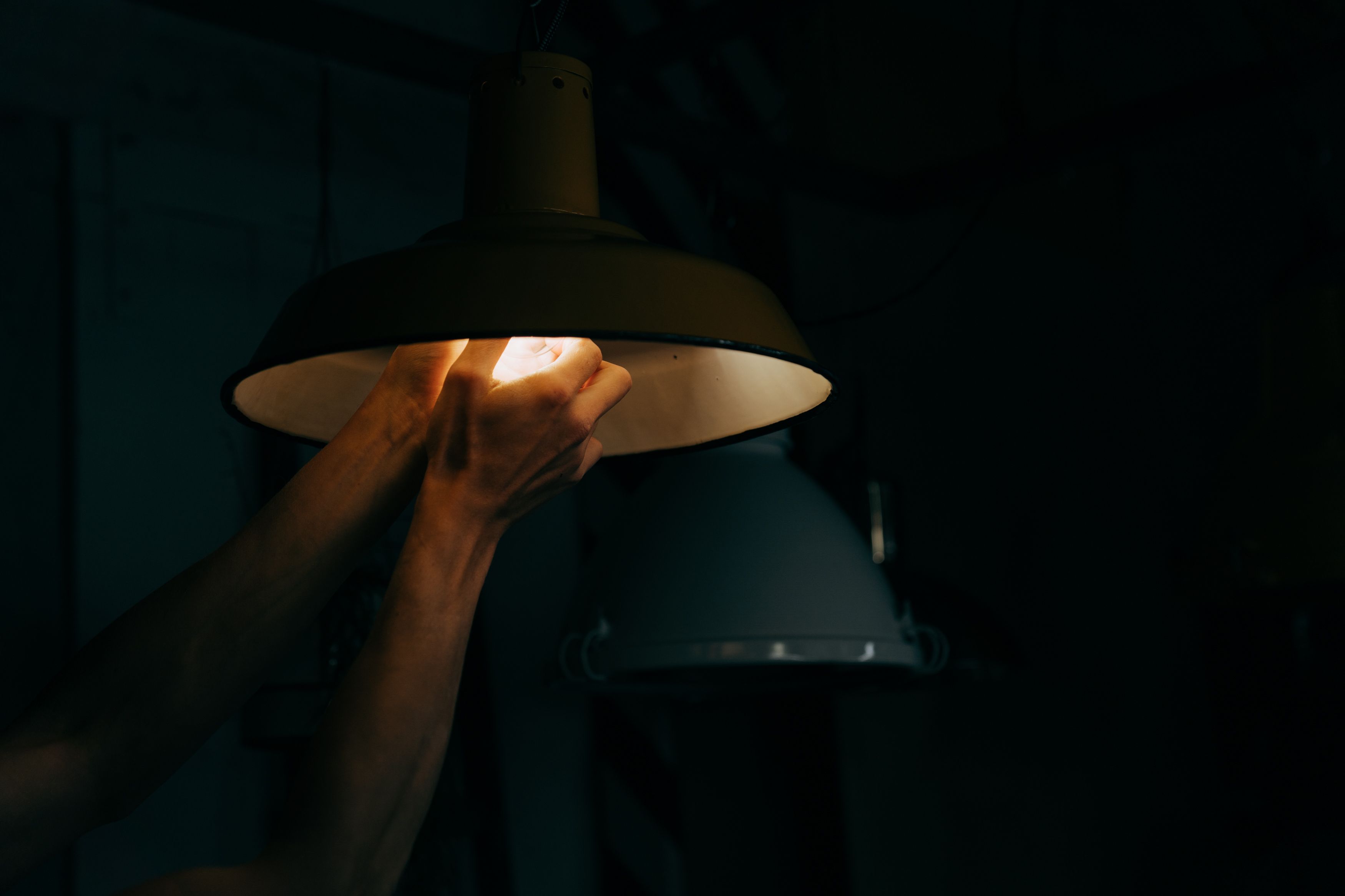Person Holding Black and White Pendant Lamp · Free Stock Photo