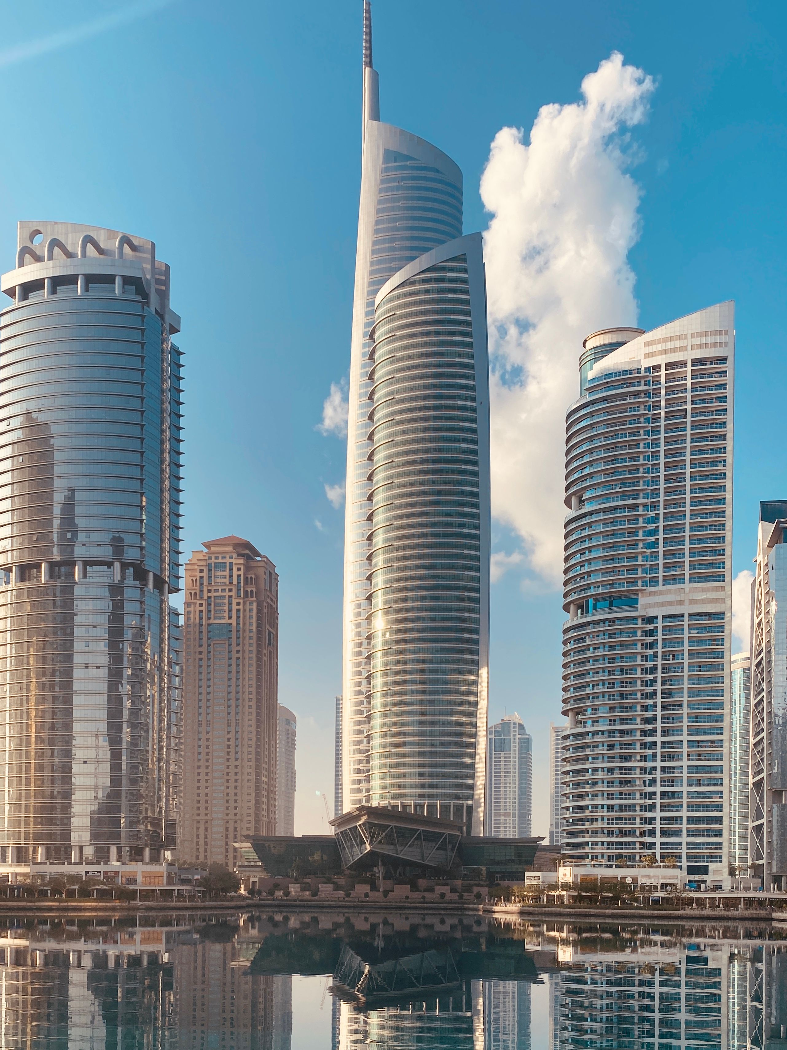 Modern skyscrapers in megapolis placed near water · Free Stock Photo