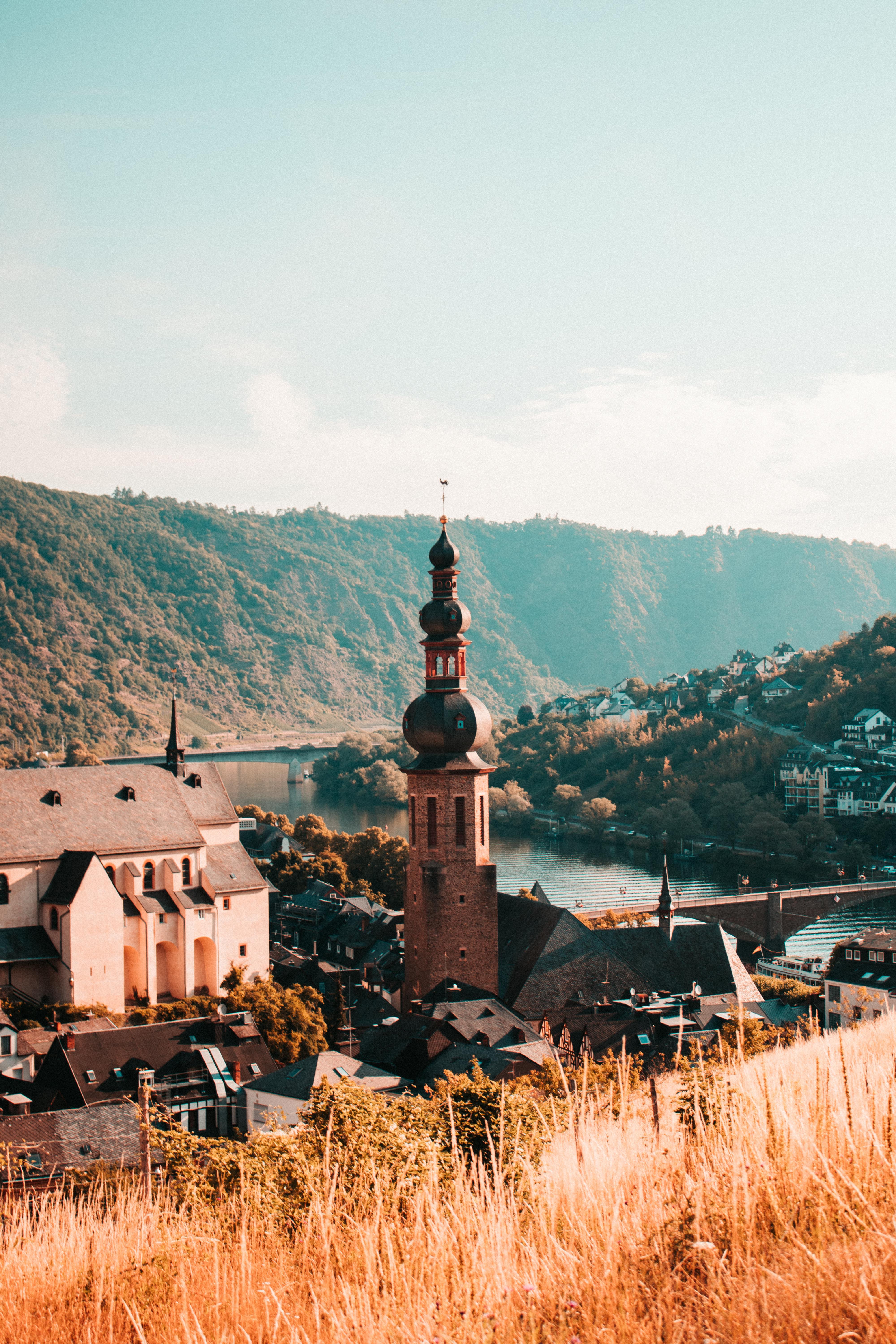 Castle on Hill over Village Near Body of Water · Free Stock Photo