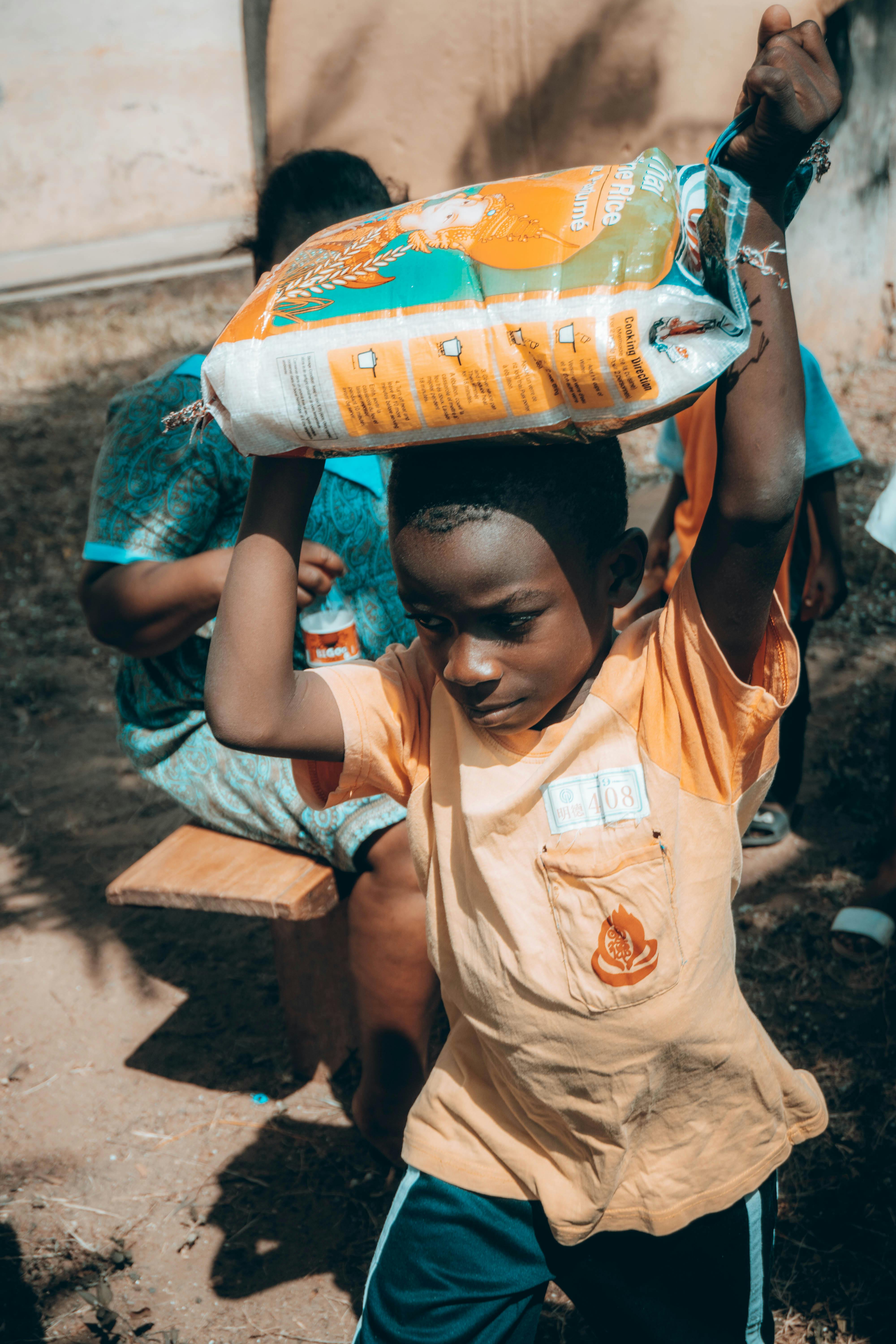 Hardworking Boy carrying a Sack of Goods · Free Stock Photo