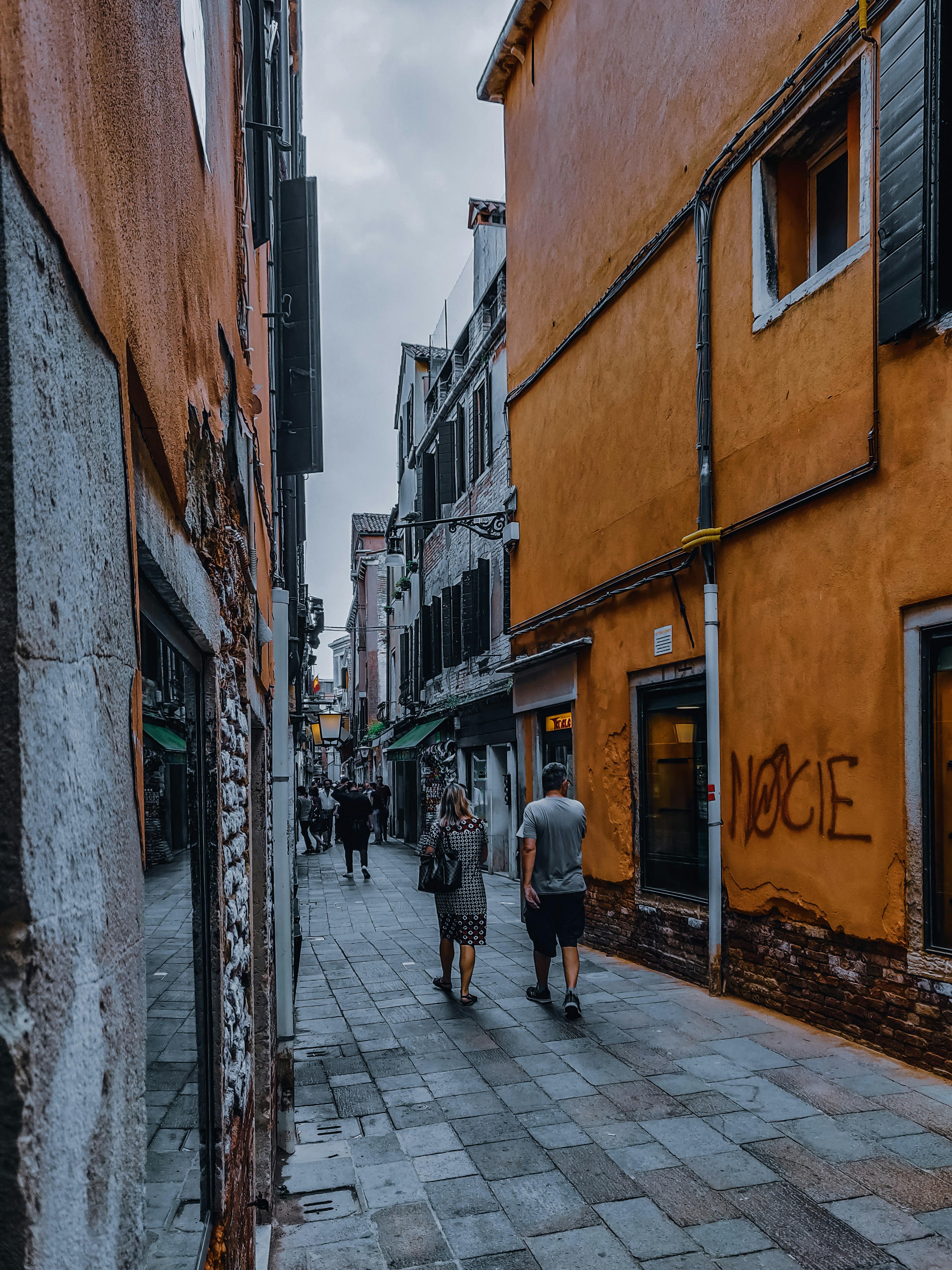 People strolling on narrow street · Free Stock Photo