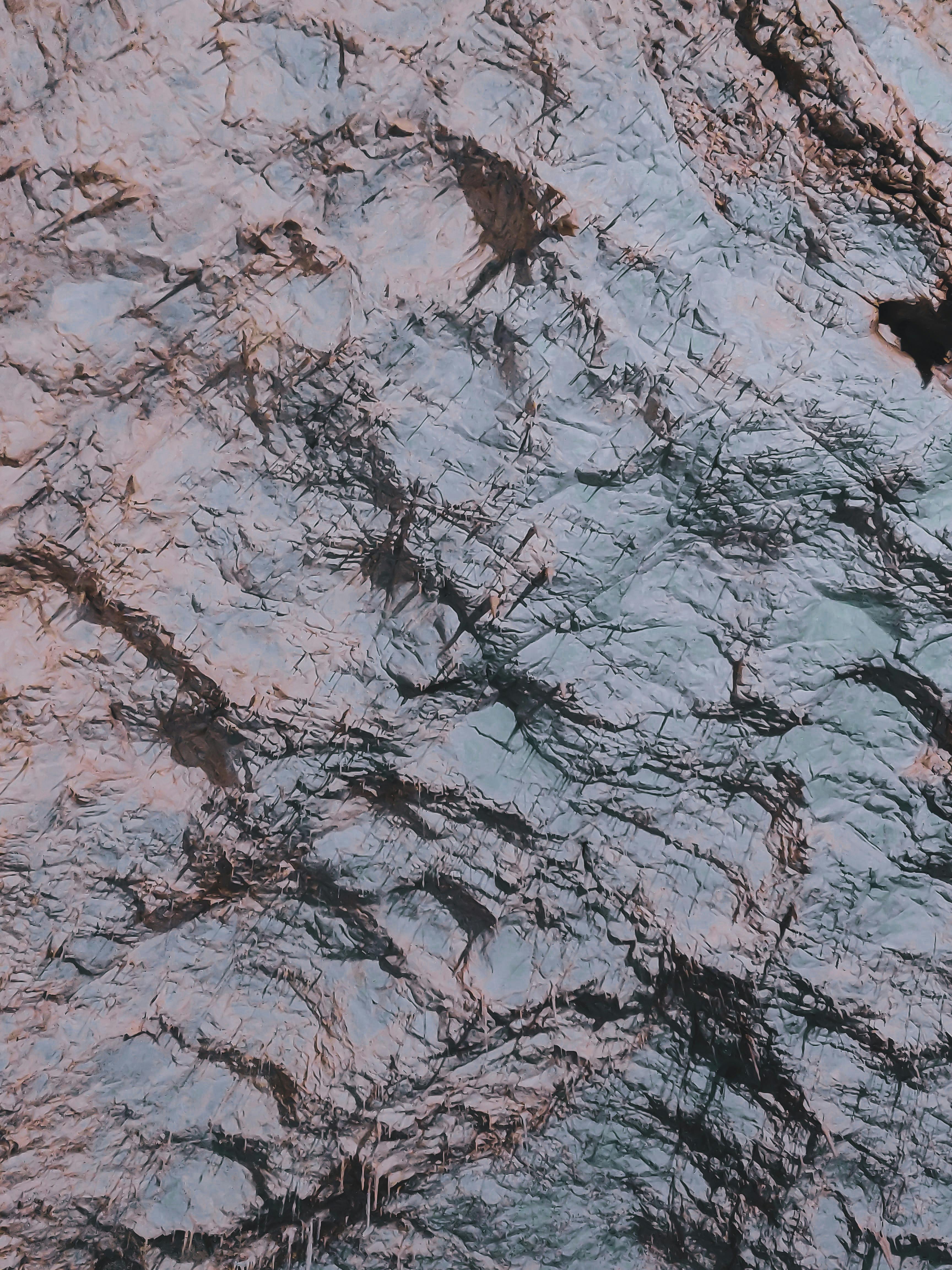 Rough frozen surface under old stone · Free Stock Photo