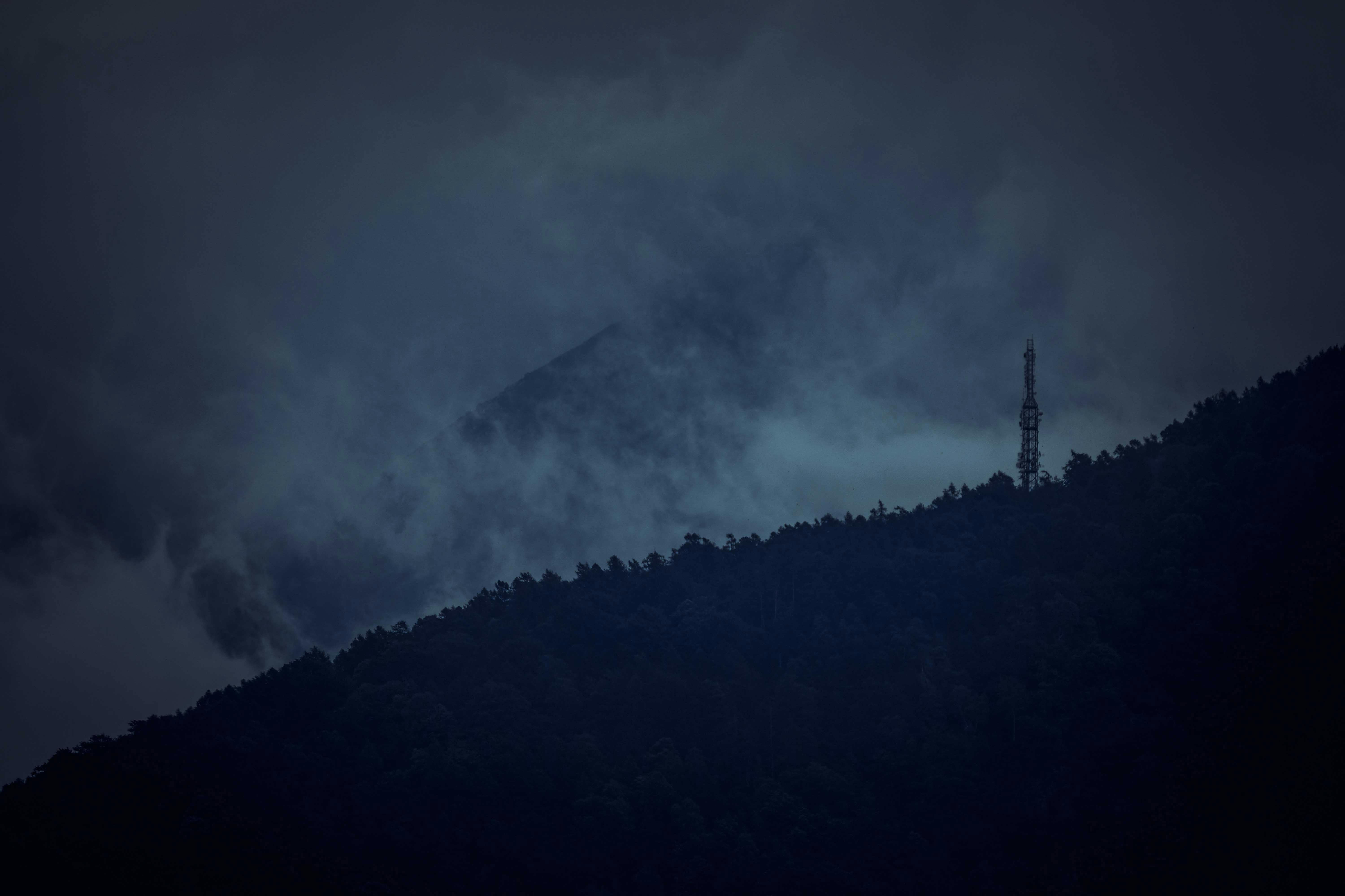 Heavy overcast skies over hills peaks at dark night · Free Stock Photo