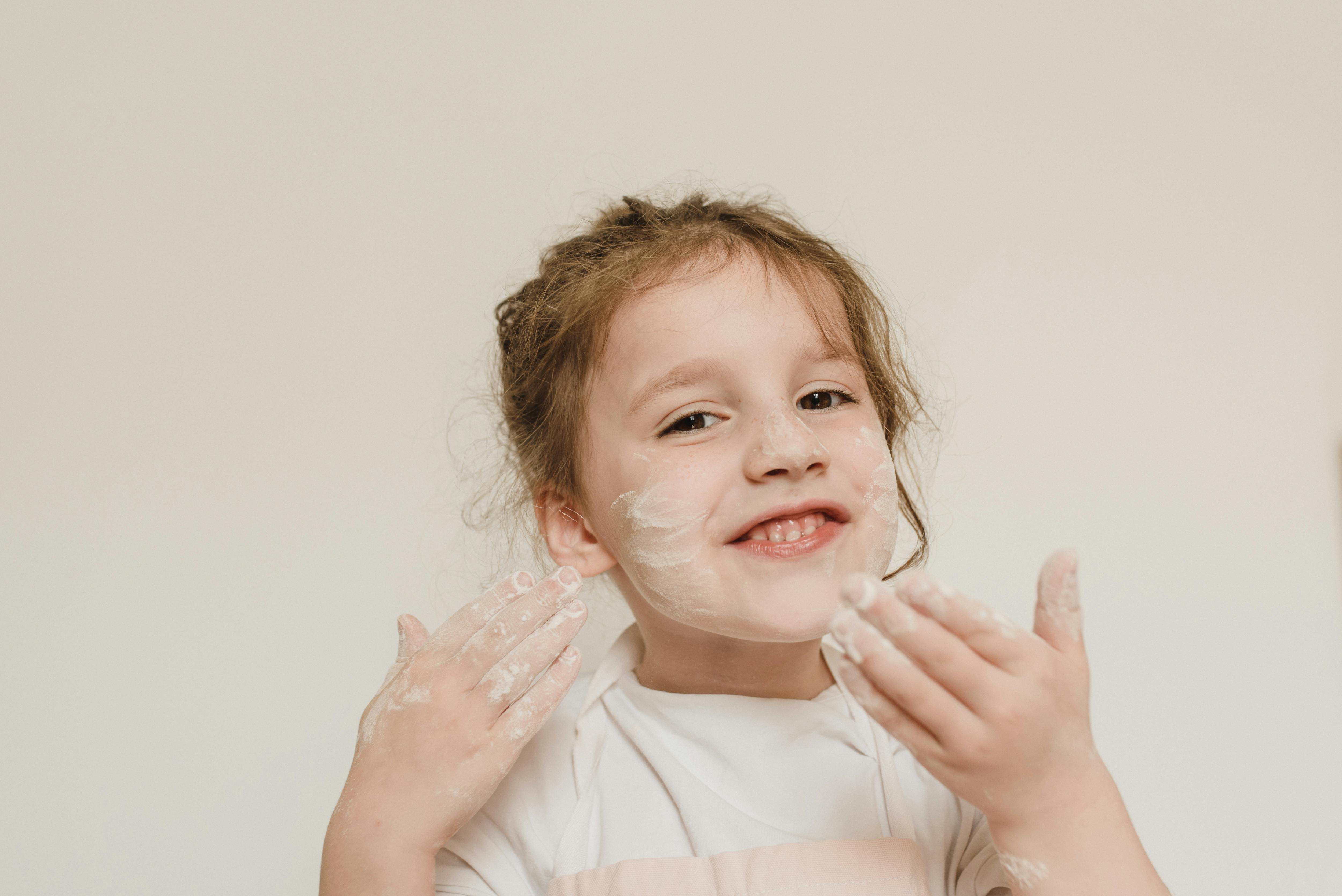 Child Putting Powder on Her Face · Free Stock Photo