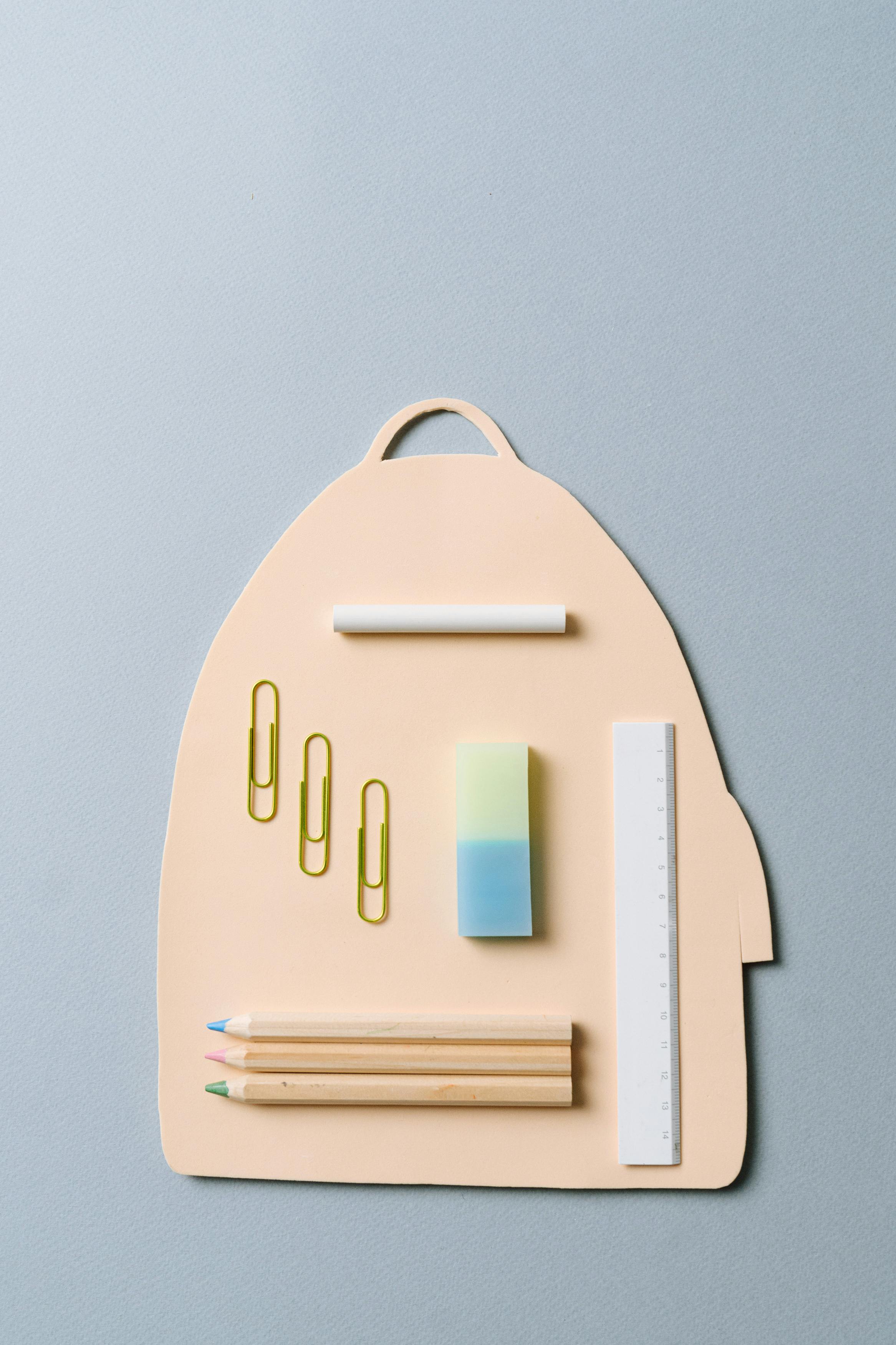 School Supplies Neatly Laid on a Cutout in a Shape of a Backpack · Free ...