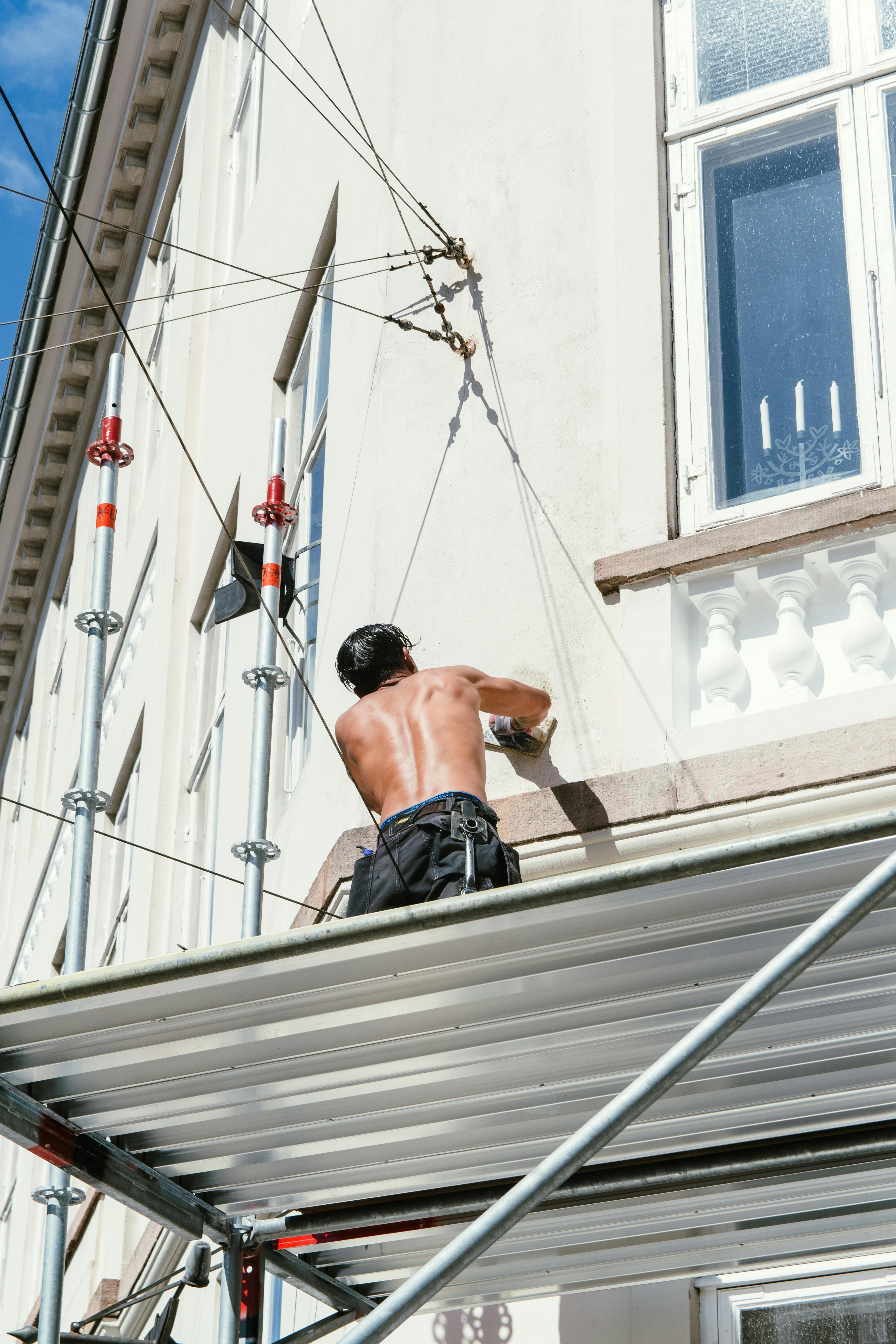 Men on Brown Scaffolding · Free Stock Photo