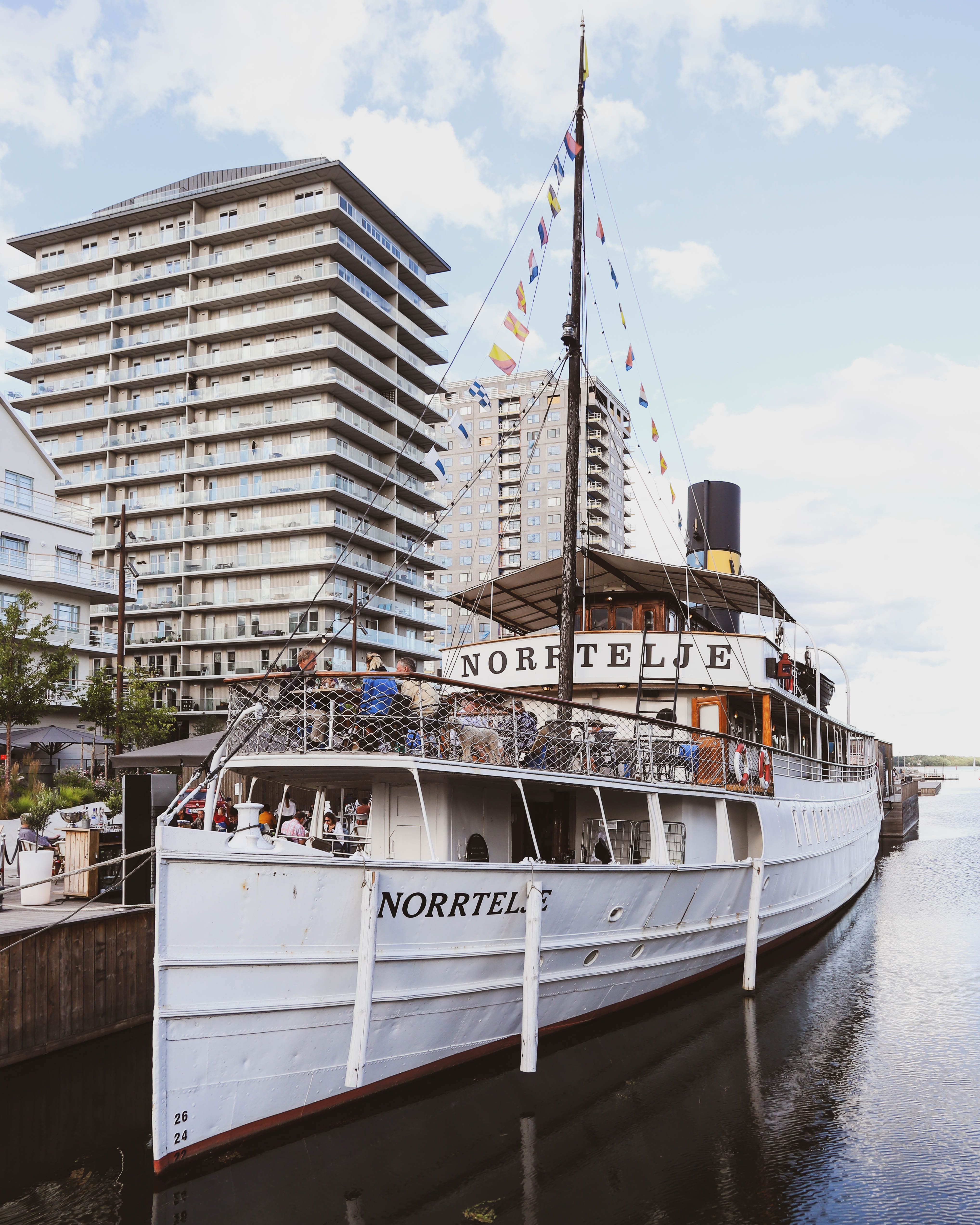 White Boat on Dock Near City Buildings · Free Stock Photo