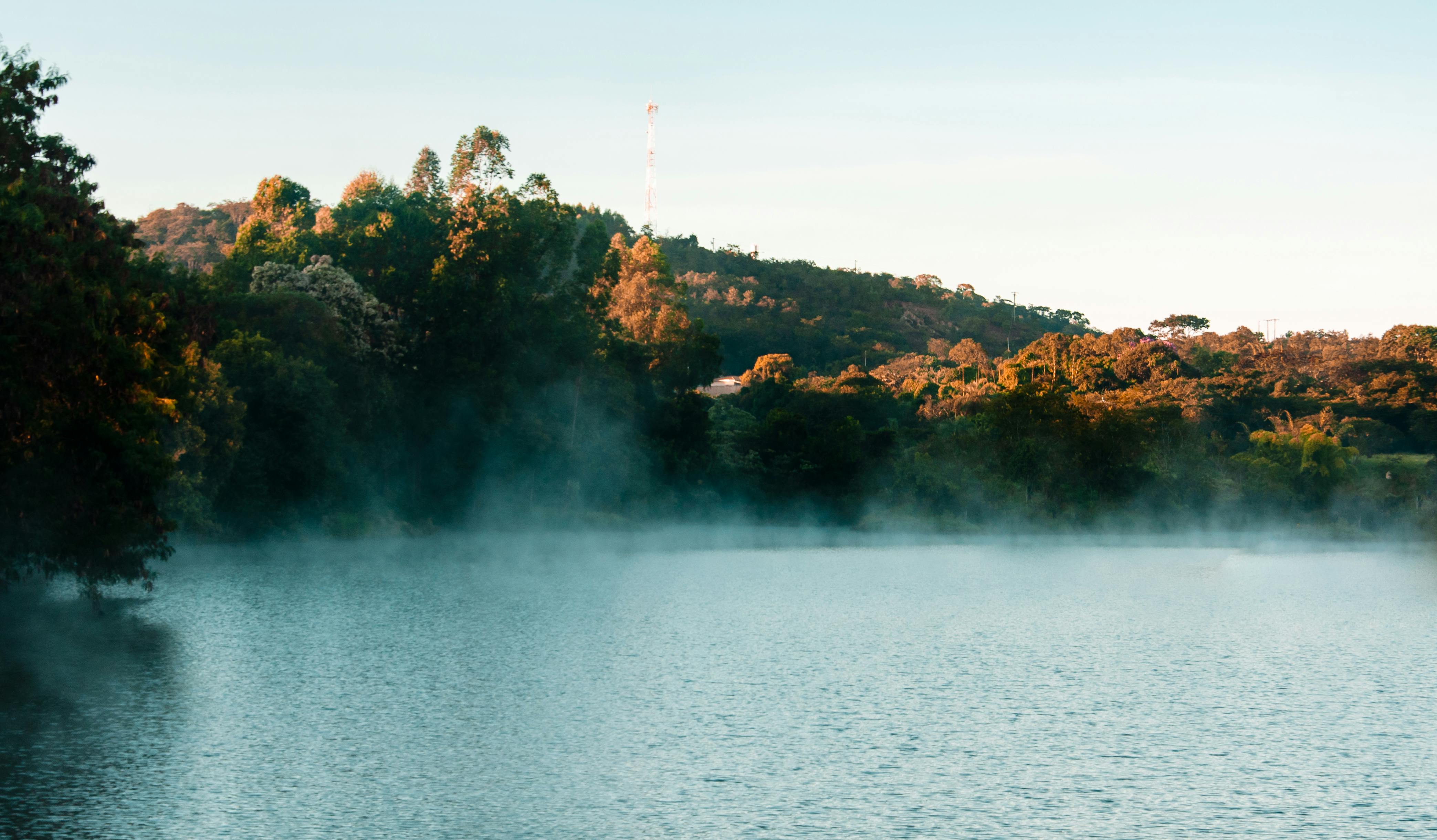 Fog Over Water Surrounded with Mountains · Free Stock Photo