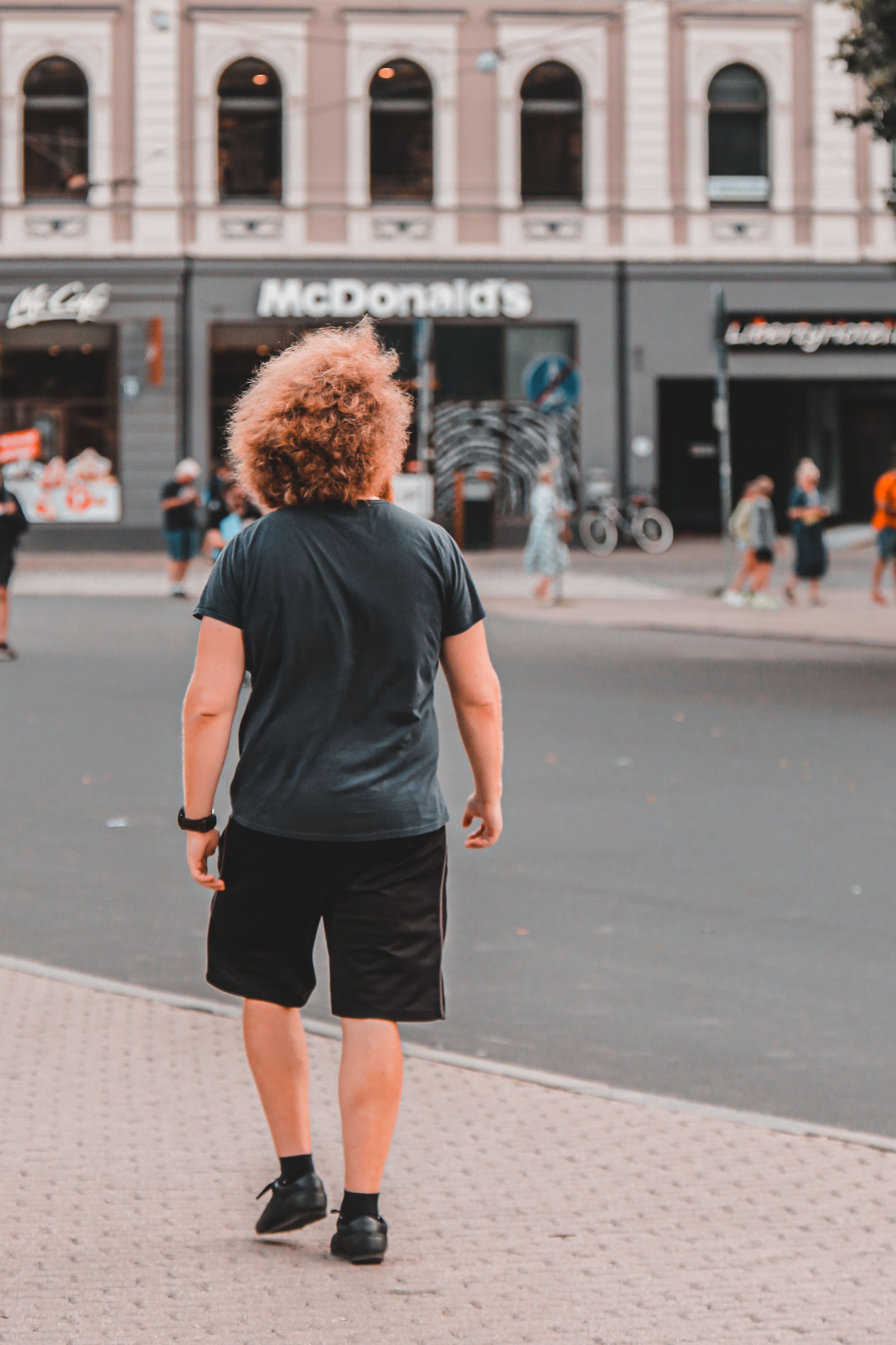 Man Walking on Sidewalk · Free Stock Photo