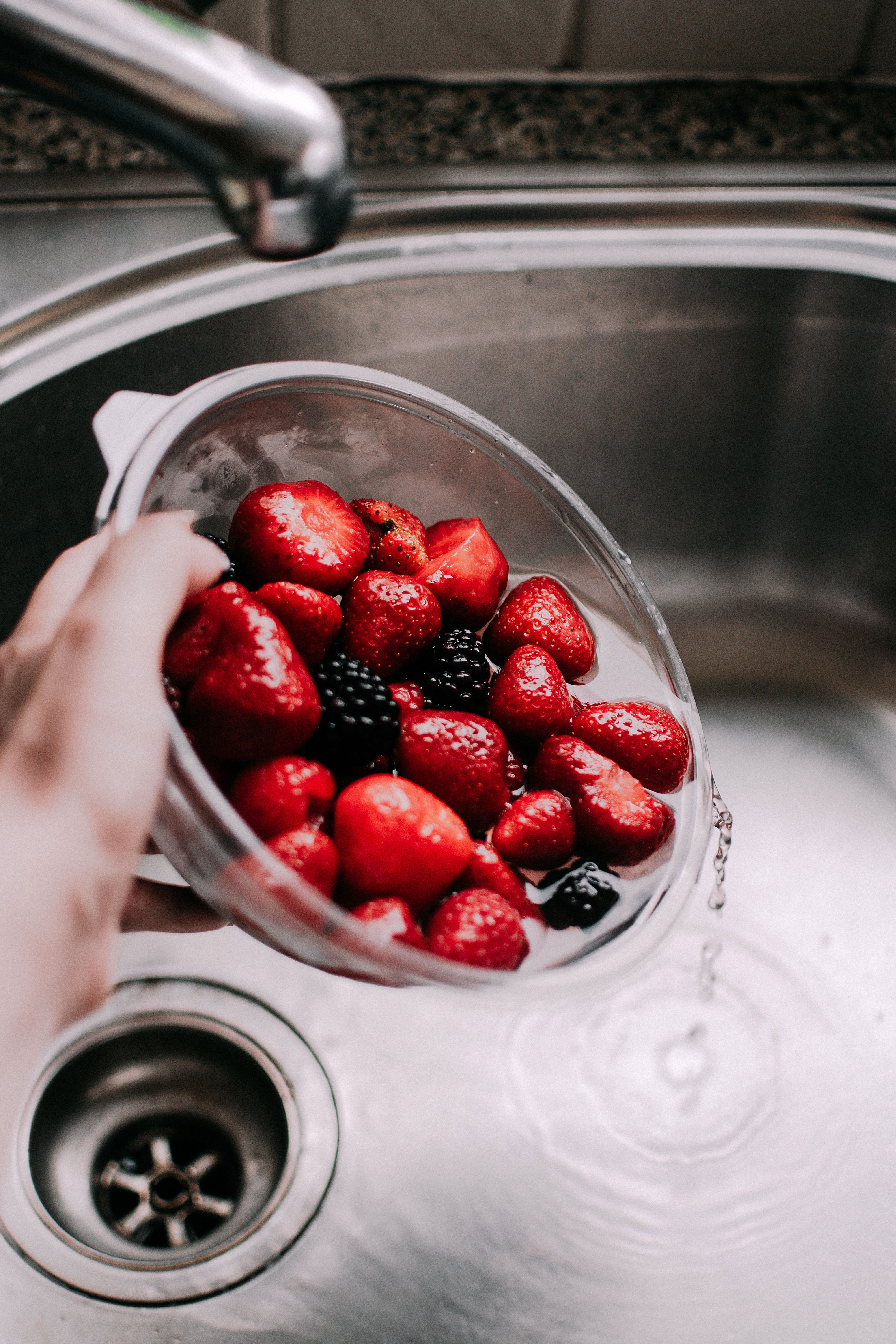 Pouring Water Out Fruit Bowl · Free Stock Photo