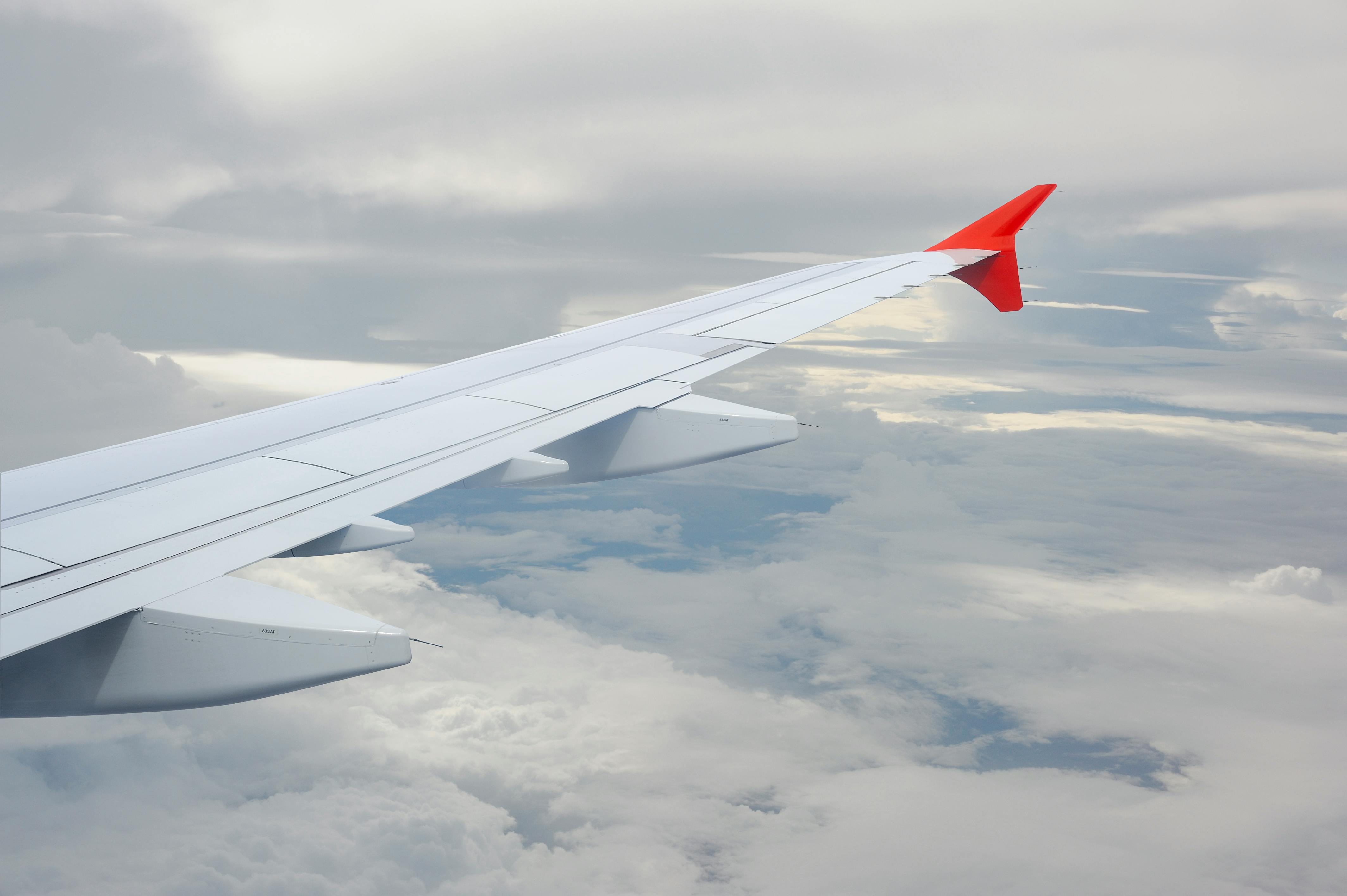 Airplane Wing Soaring Through the Clouds · Free Stock Photo