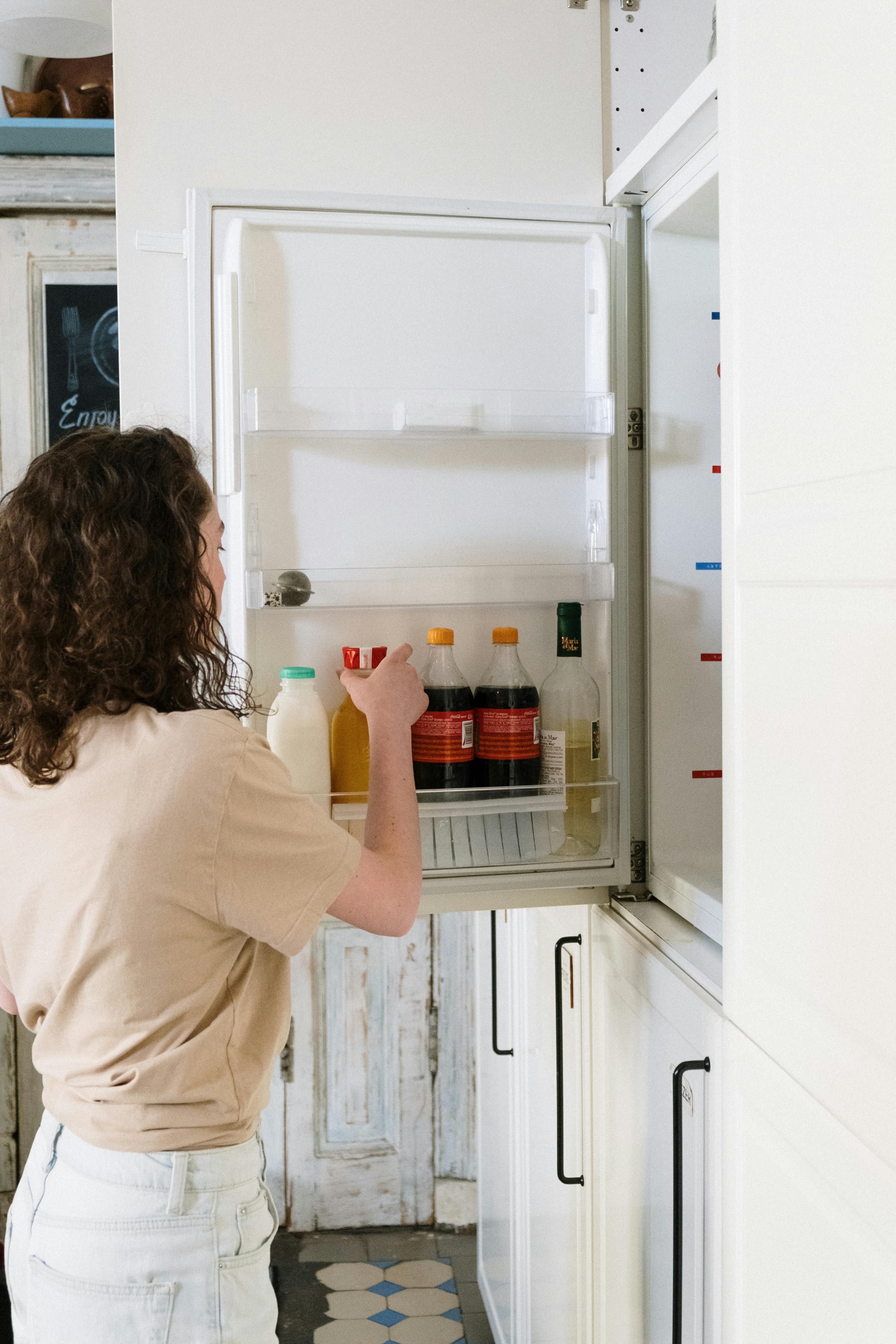 A Woman Opening a Refrigerator · Free Stock Photo