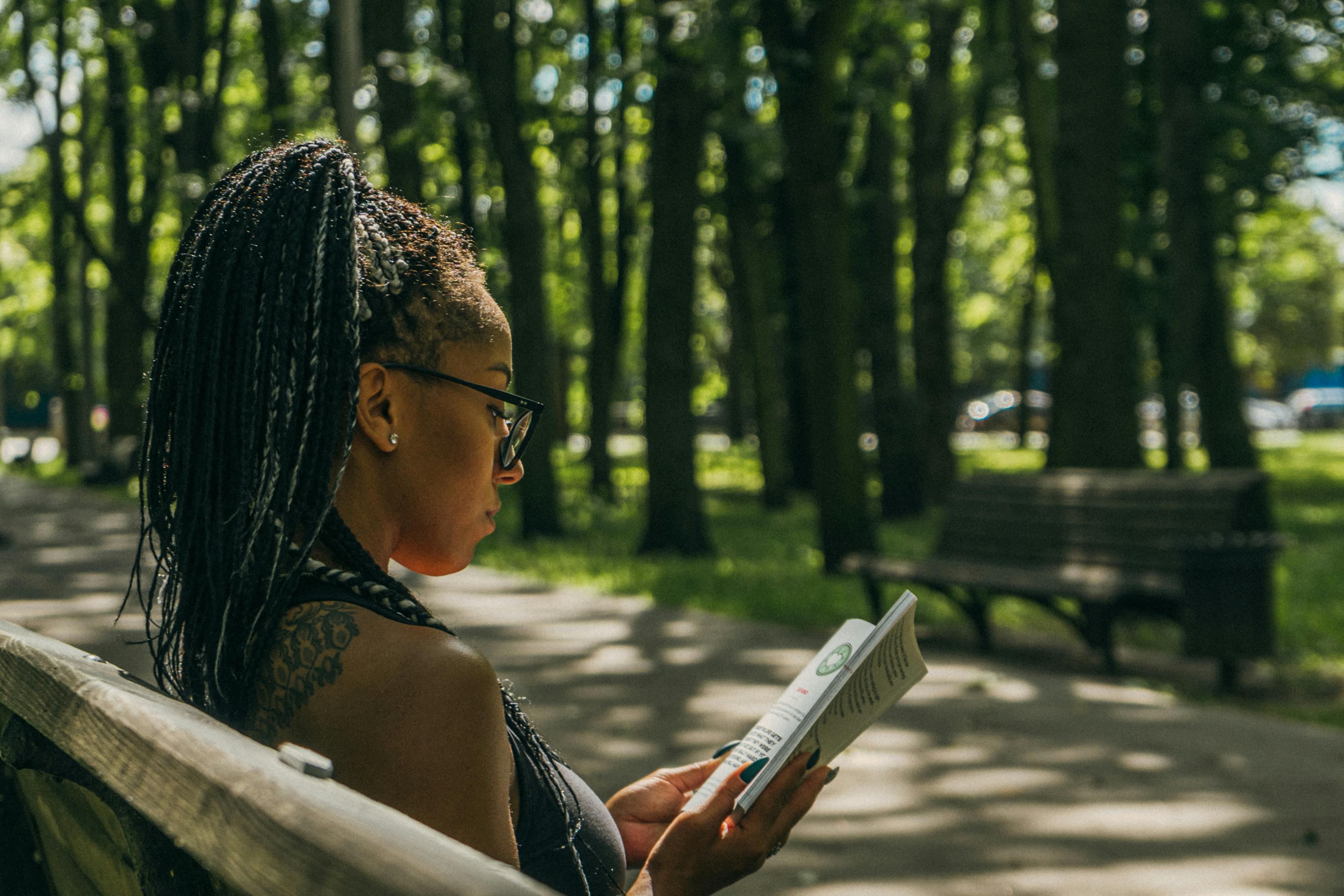 Woman with Braided Hair Reading a Book · Free Stock Photo
