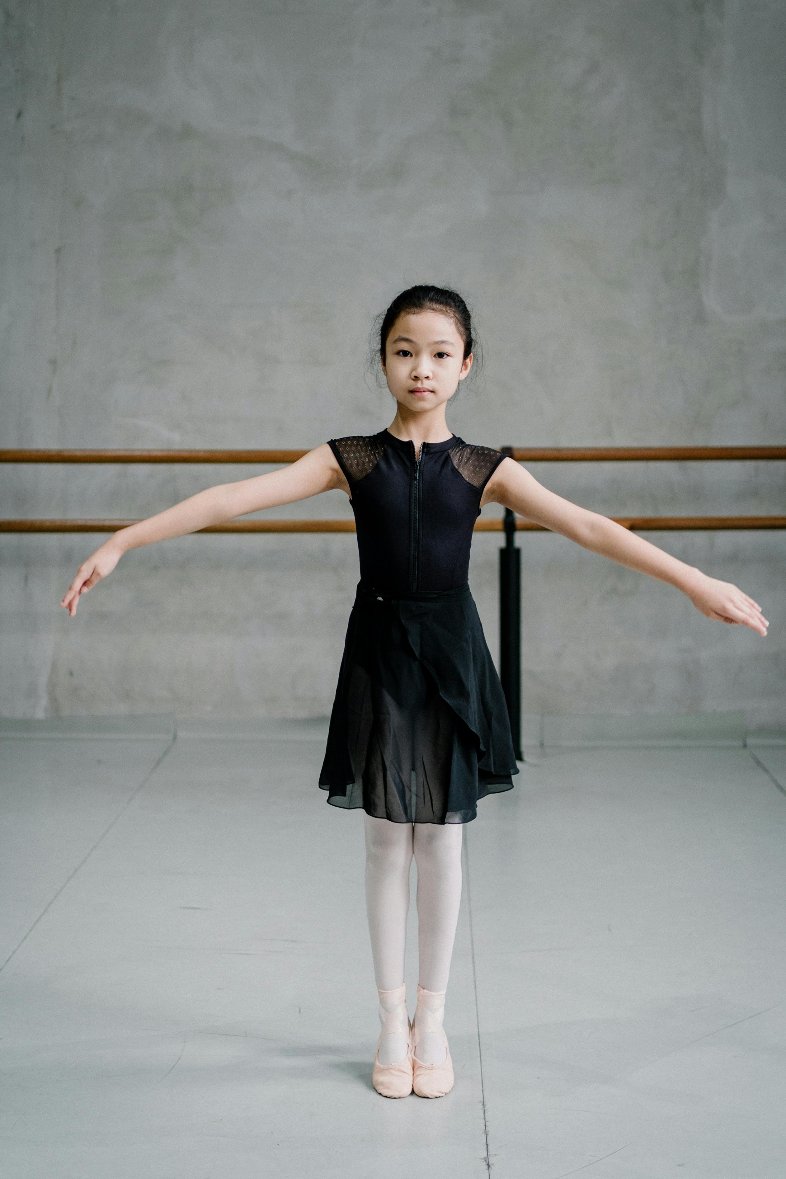 Graceful dancer performing on street standing in puddle · Free Stock Photo