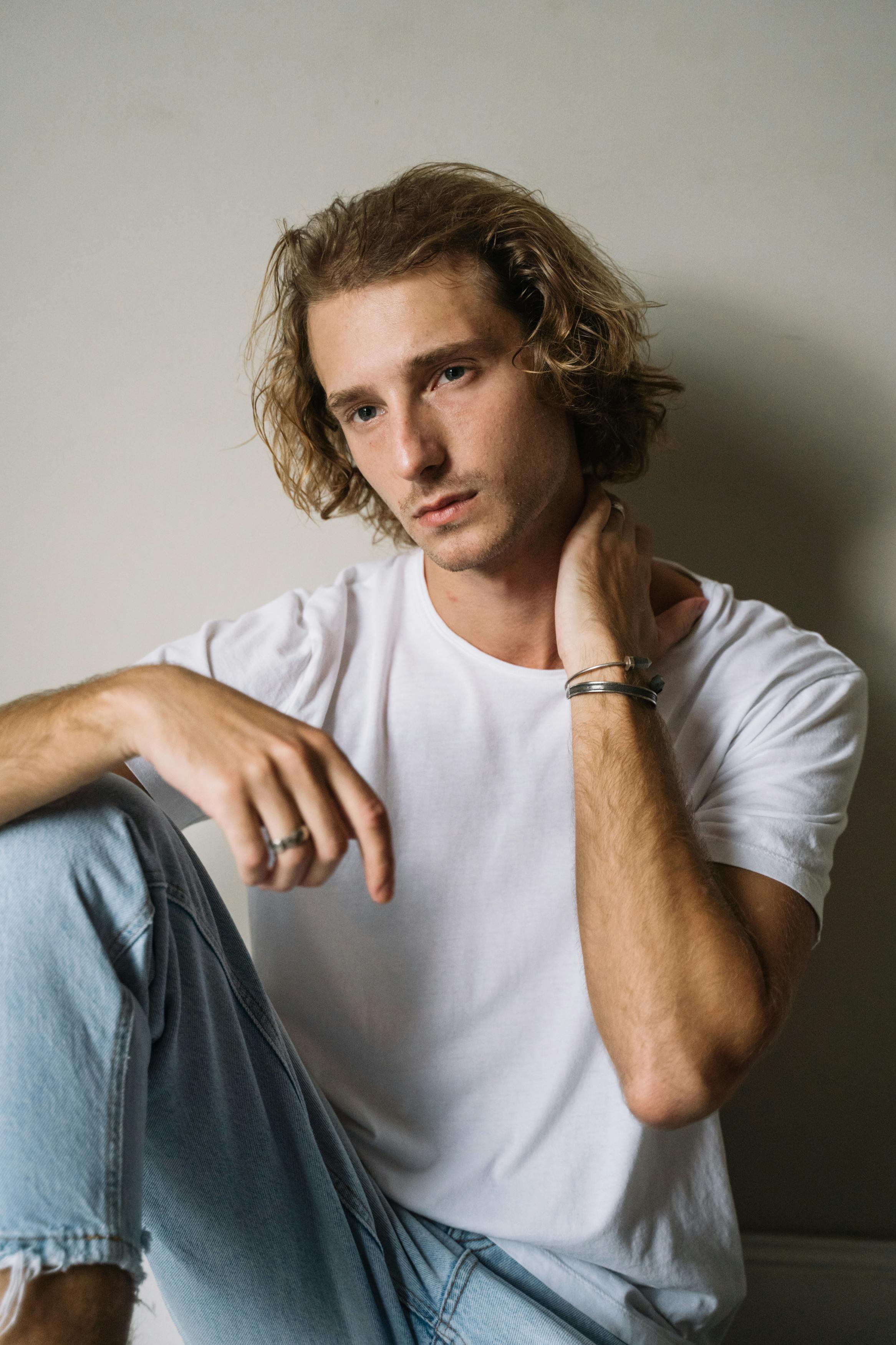 Man in White Crew Neck T Shirt Touching His Nape · Free Stock Photo