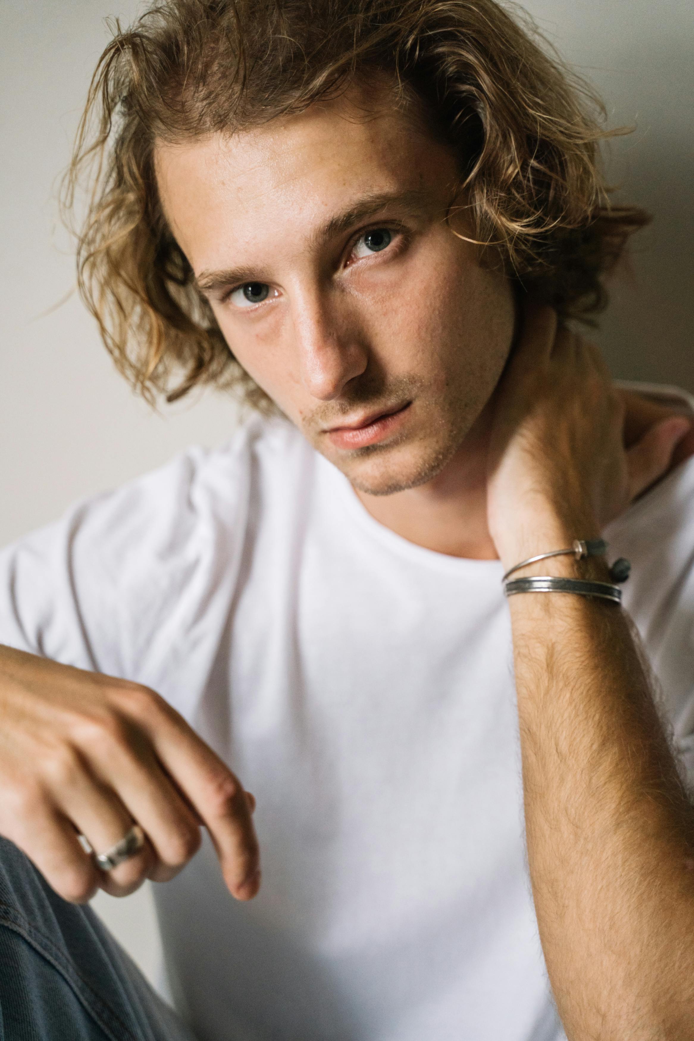 Man in White Crew Neck T Shirt Touching His Nape · Free Stock Photo