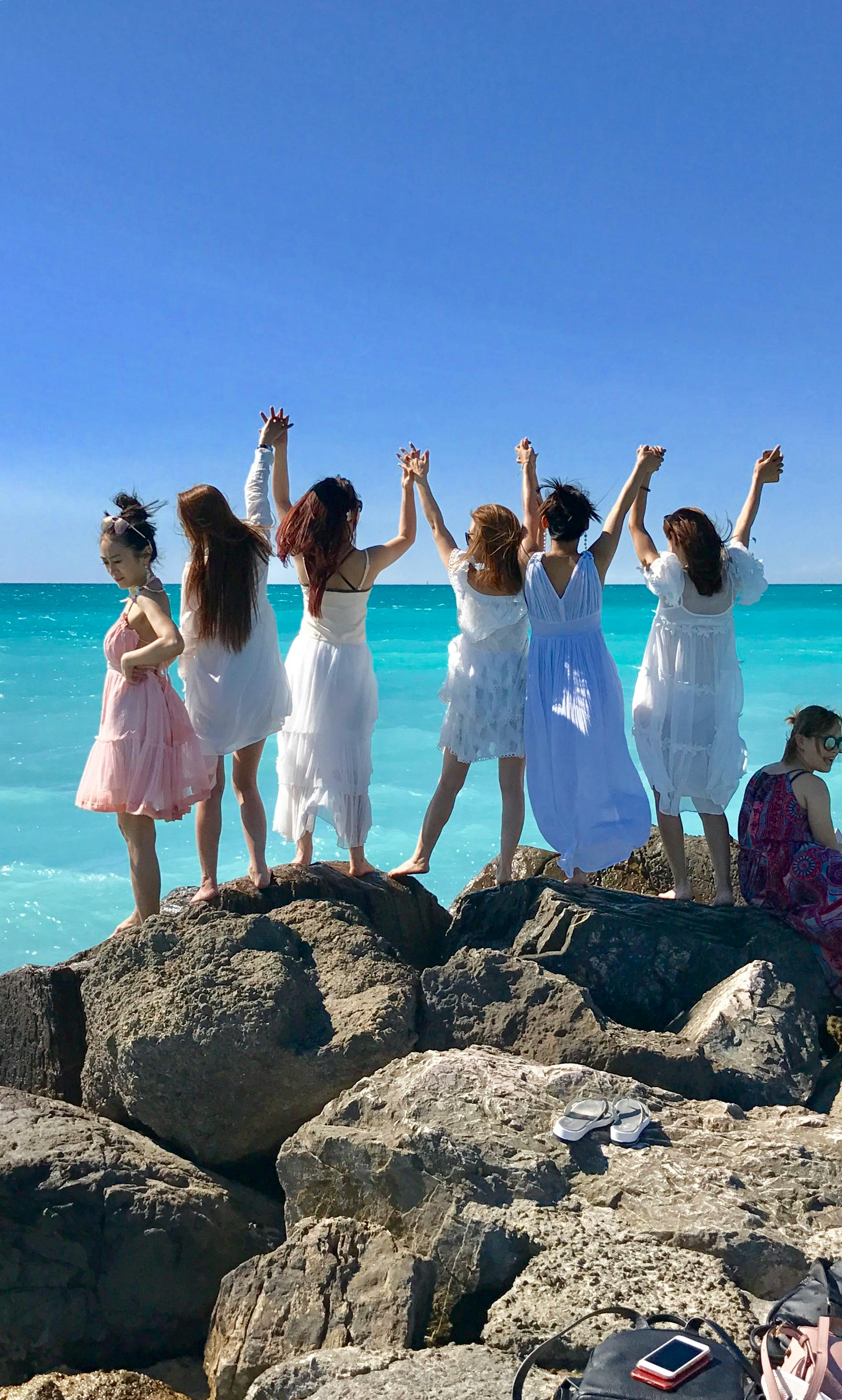 Women on Rocks on Sea Shore · Free Stock Photo